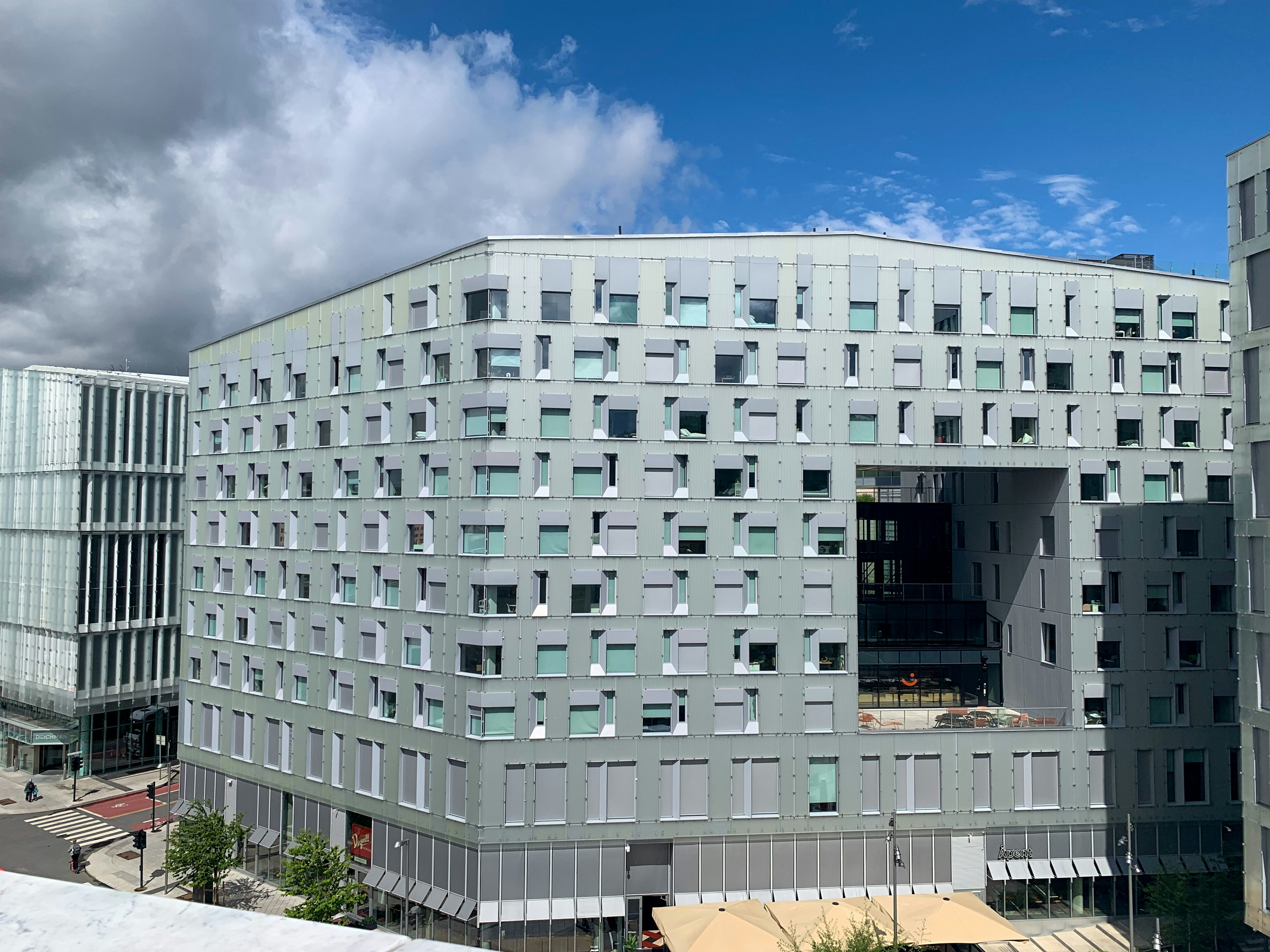 A large grey building with lots of windows photo – Free Grey Image on ...