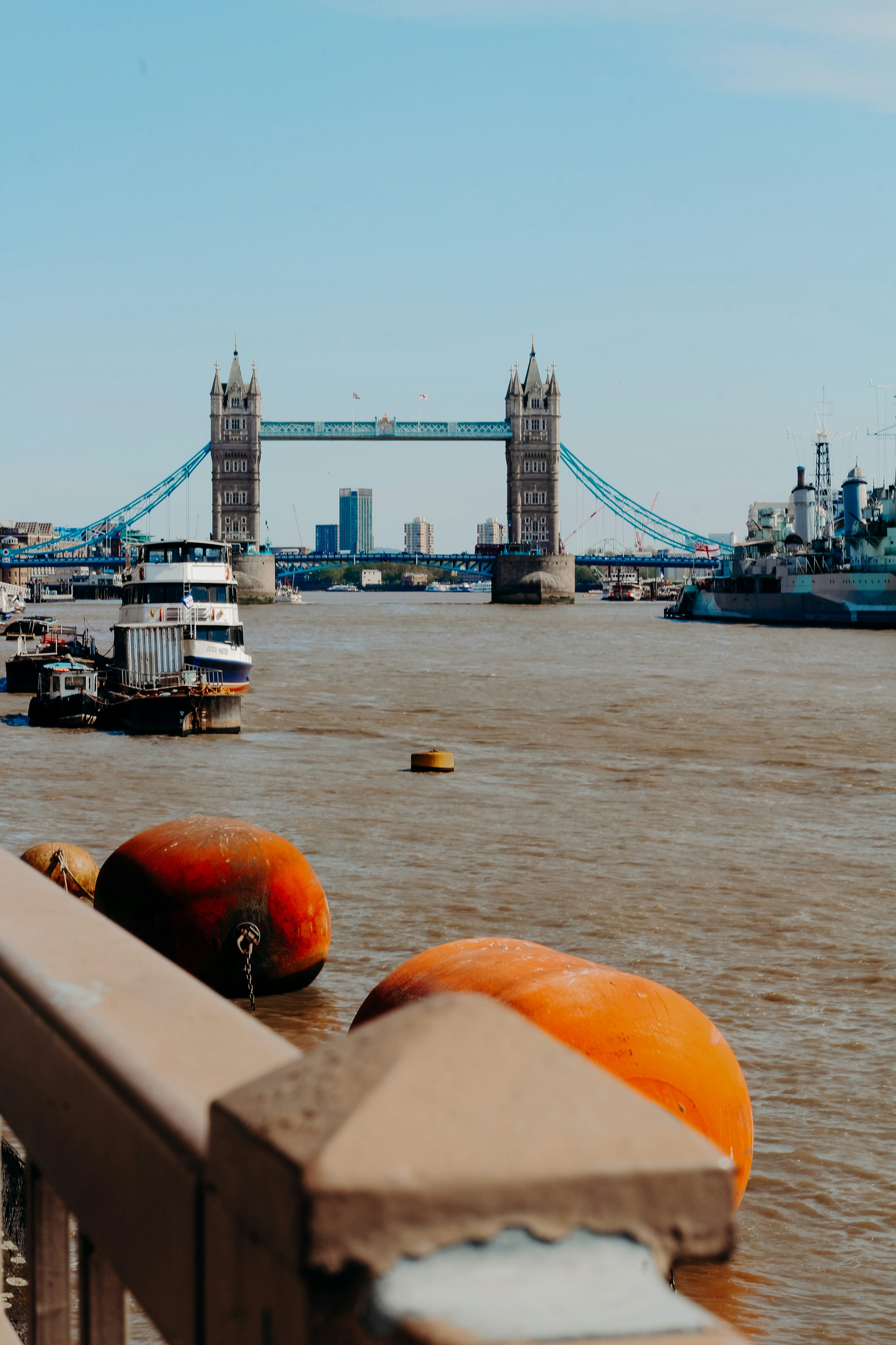 Towering Blue: Tower Bridge Framed Over the Thames with Moored Barges