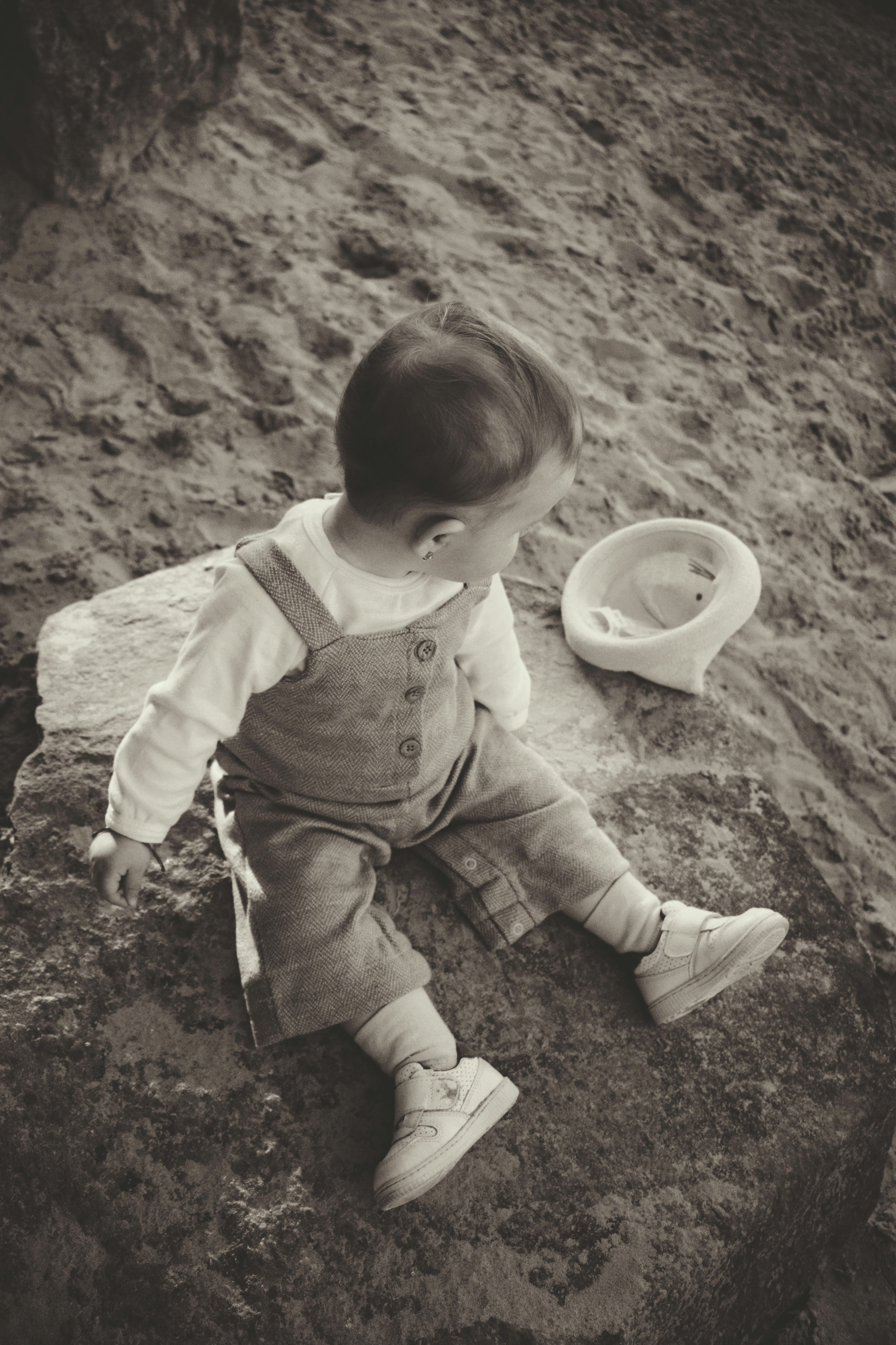 Child on a Stone: Quiet Playground Moments
