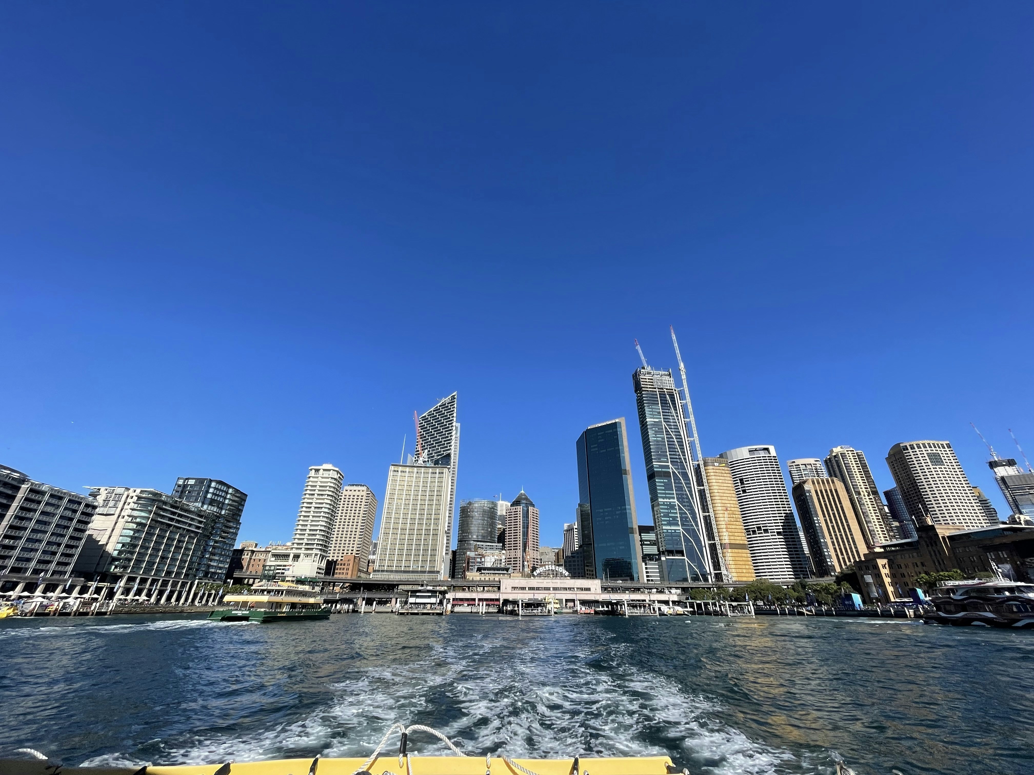 Harborfront Glass Ridge: Skyline Under a Clear Blue Ceiling
