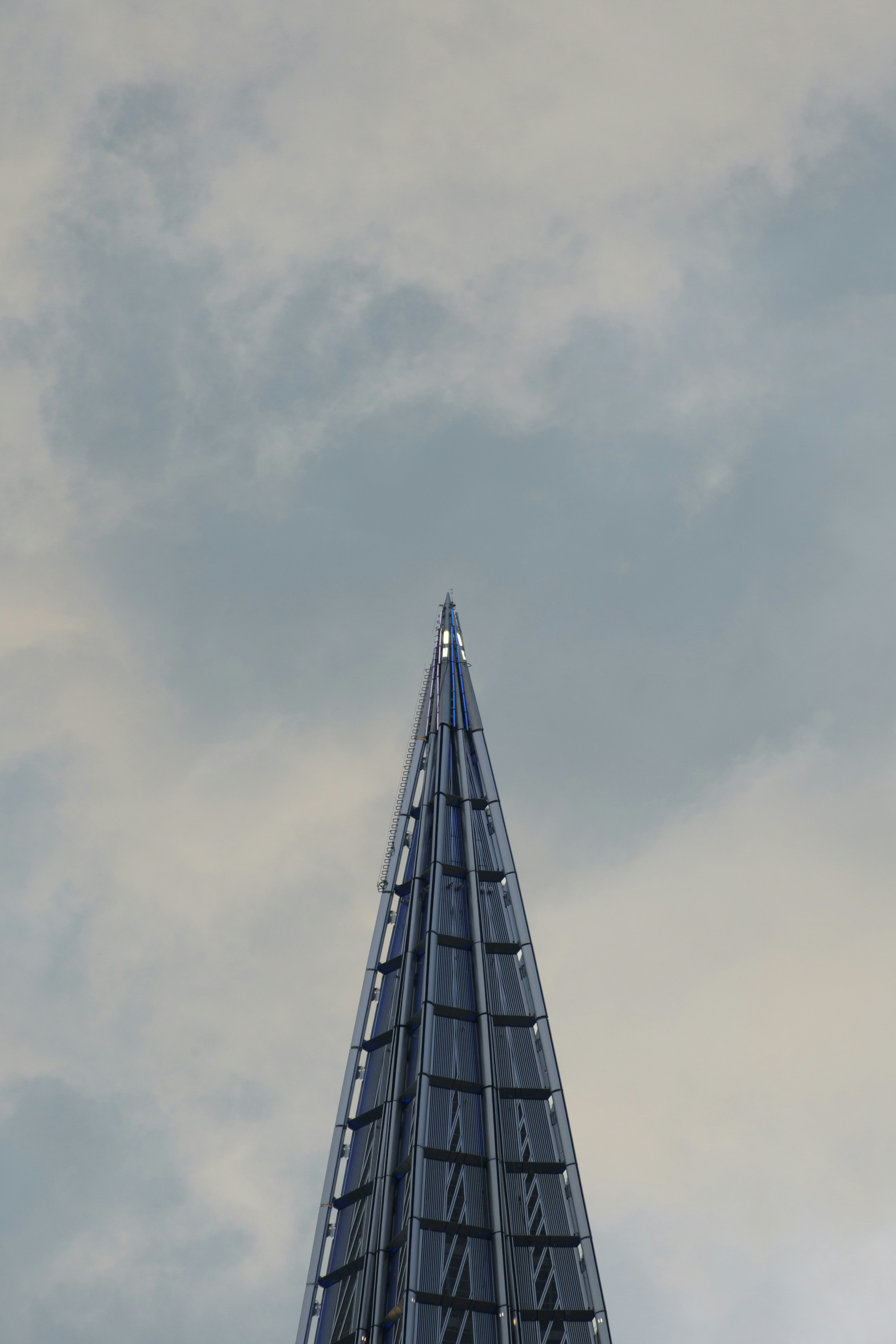a large tall tower with a clock on a cloudy day