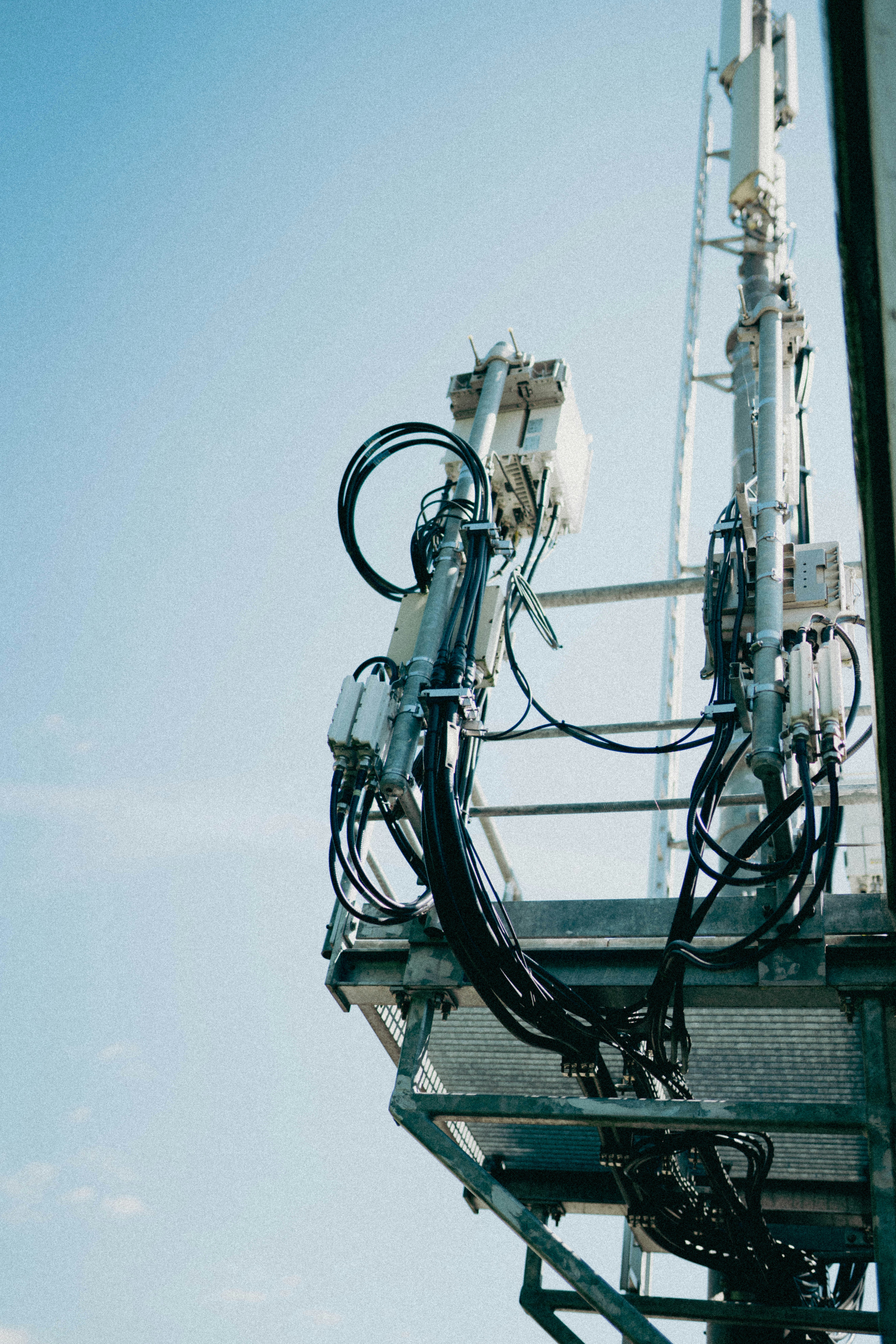 A cell phone tower with multiple wires attached to it photo – Free Grey ...