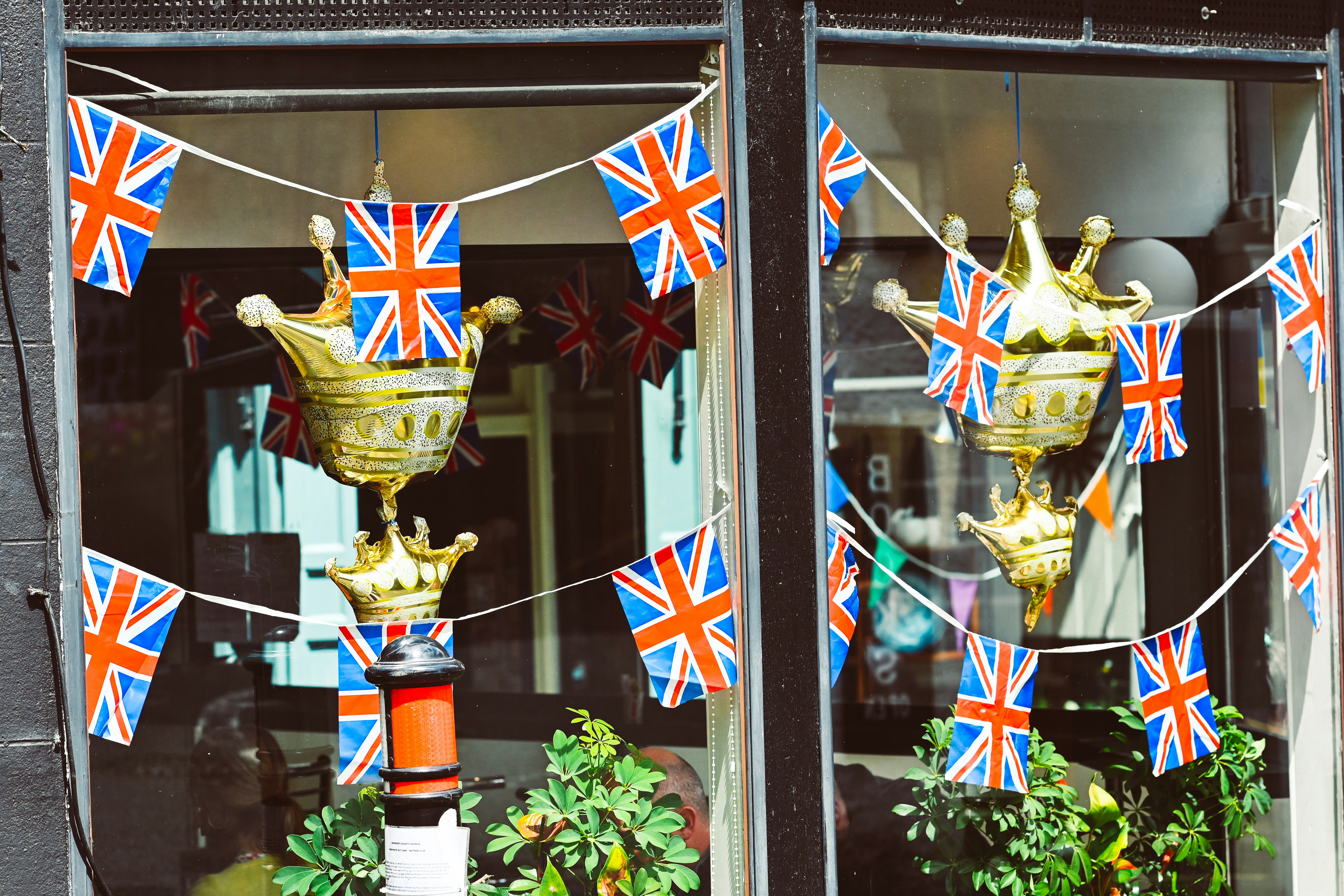 Golden trophy adorned with Union Jack flags, reflecting the vibrant atmosphere of a festive street scene.