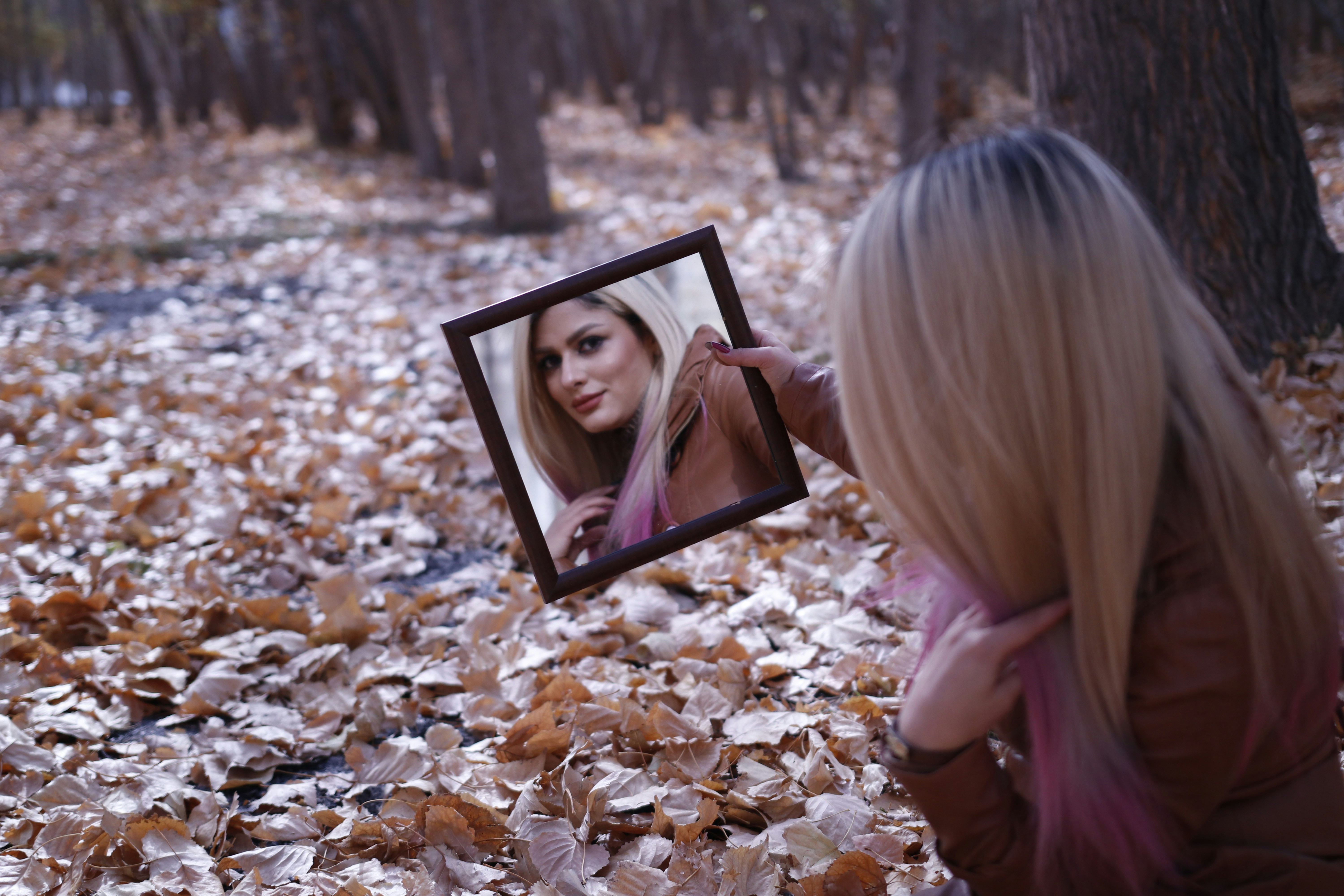 Autumn Reflection: A Woman in the Forest Reaches for Her Framed Moment