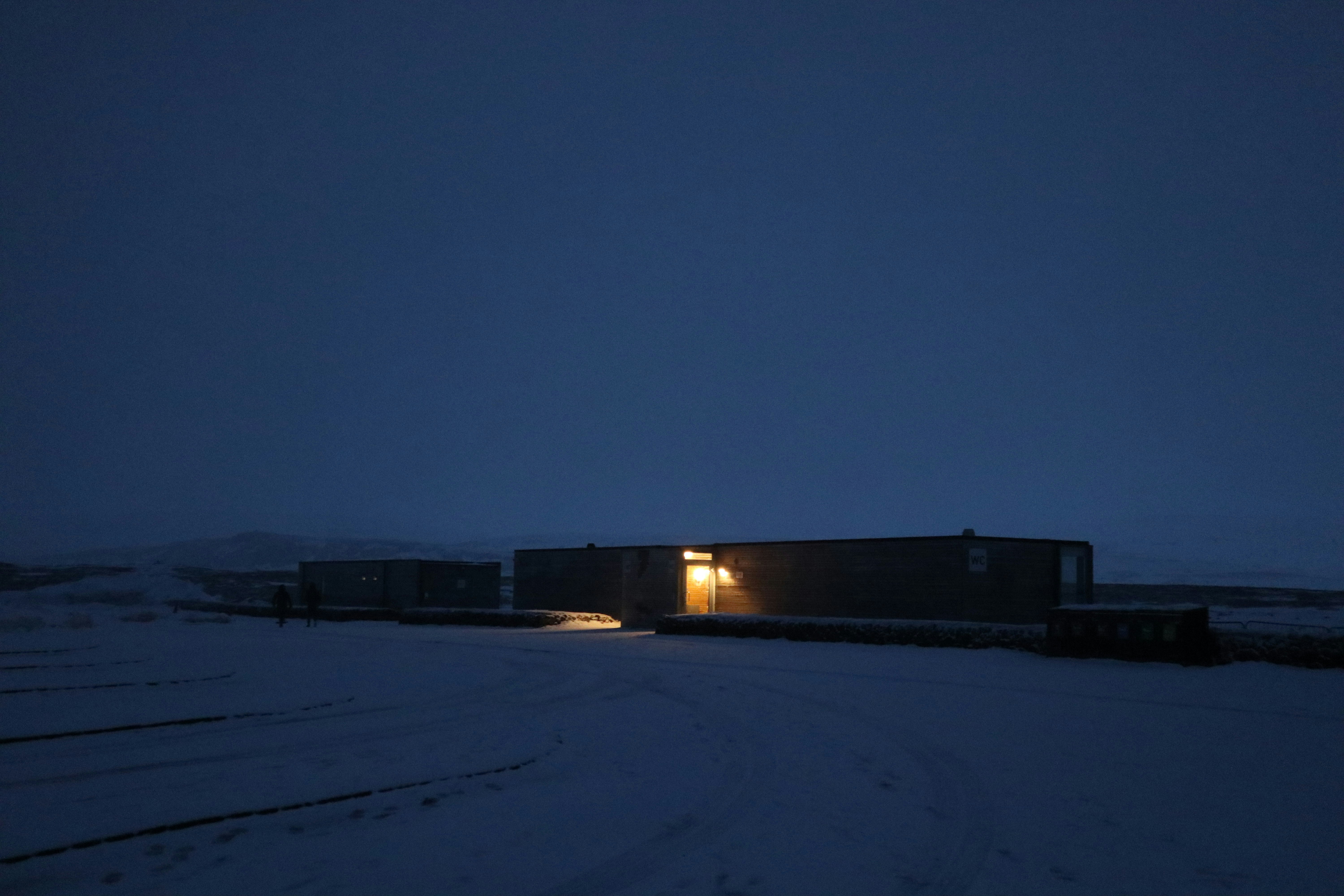 A train traveling through a snow covered countryside at night photo ...