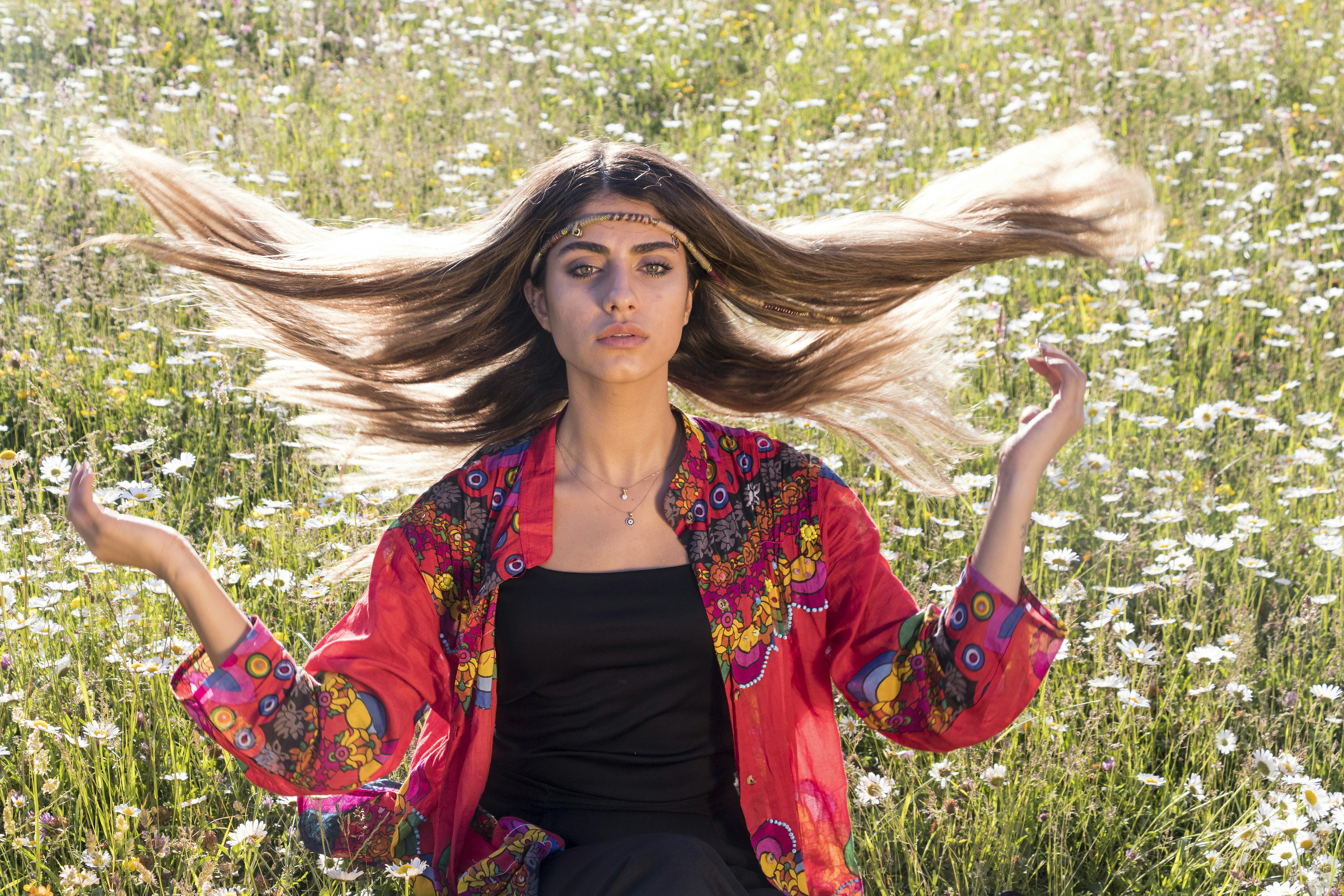 Red Silk in a Meadow: Portrait Amid Wind-Swept Daisies