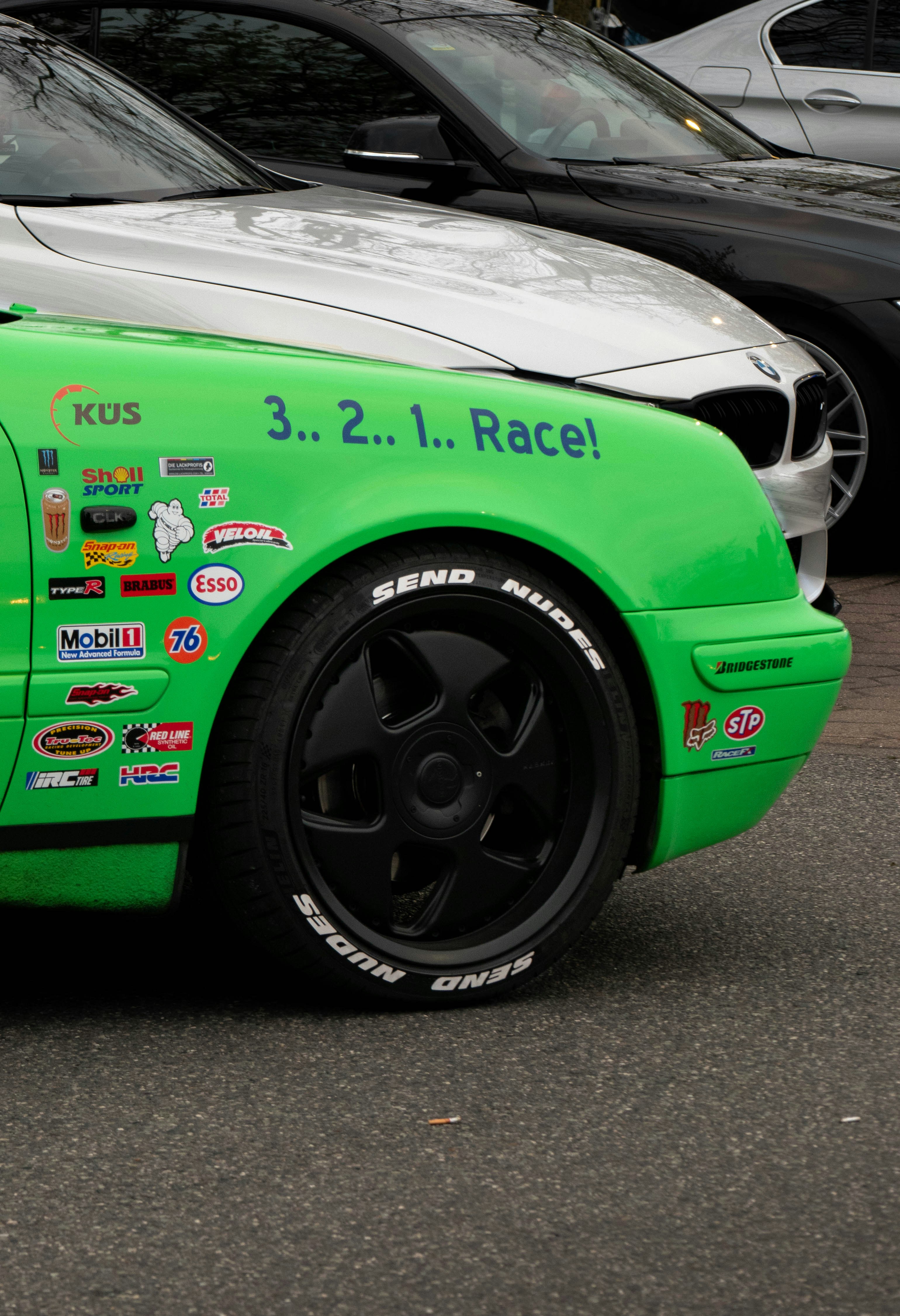 Vibrant green car with racing decals and a playful countdown slogan on the side. The sporty design captures the essence of competitive spirit.
