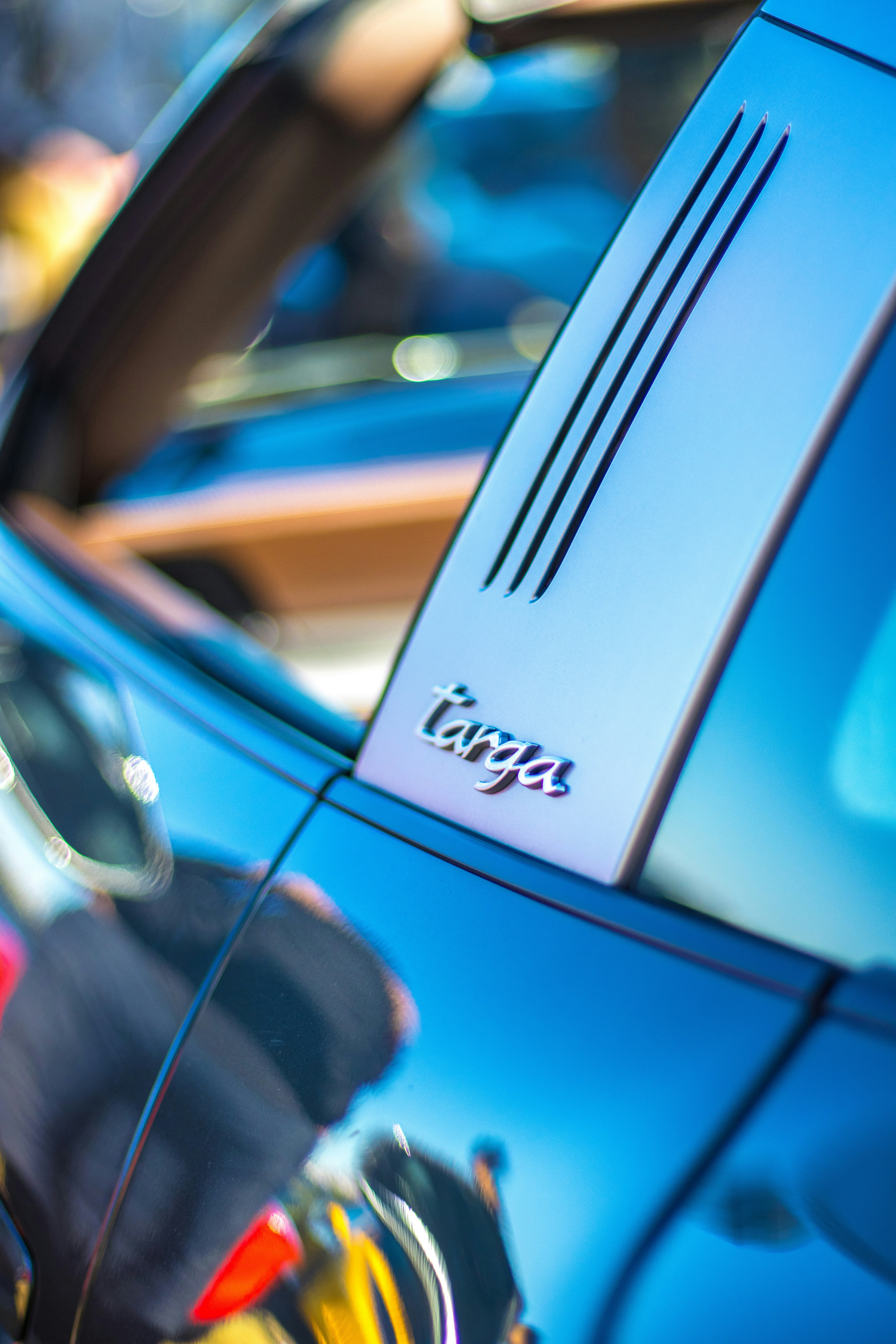 Blue Targa Portrait: close-up of Porsche badge and vented panel