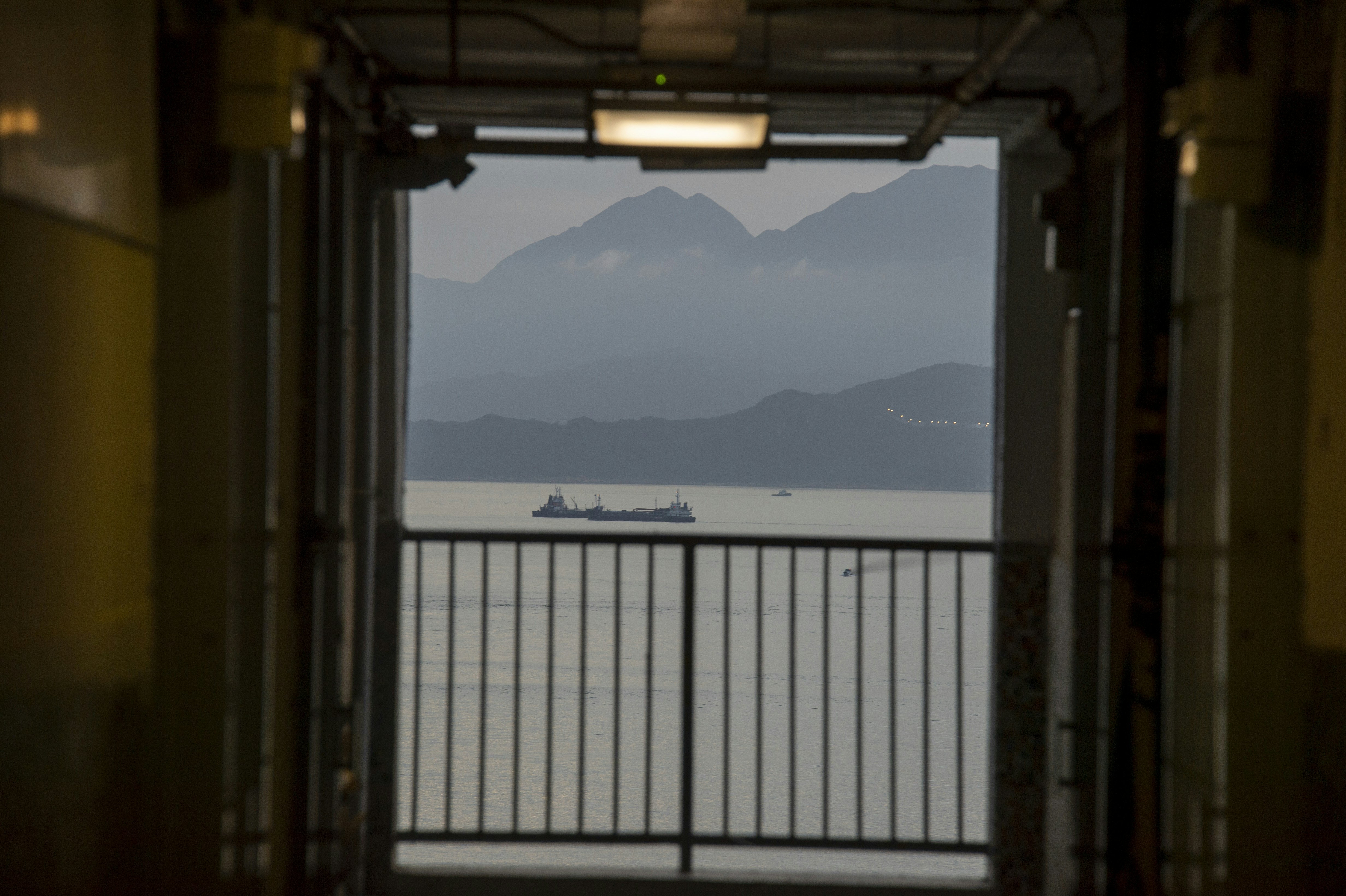 Framed Ferry: Quiet Sea Beyond the Tunnel Window