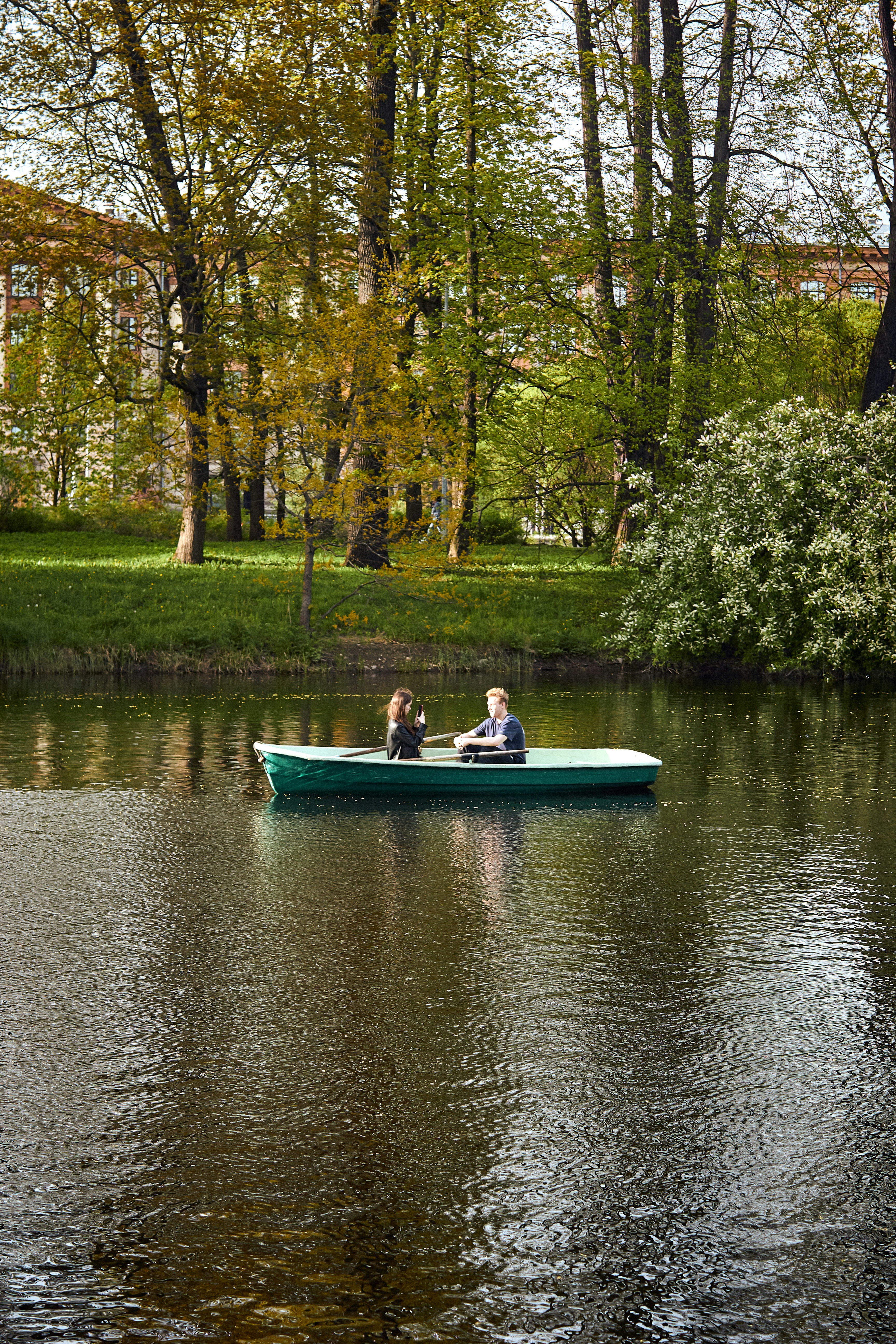 a man and a dog in a small boat on a lake
