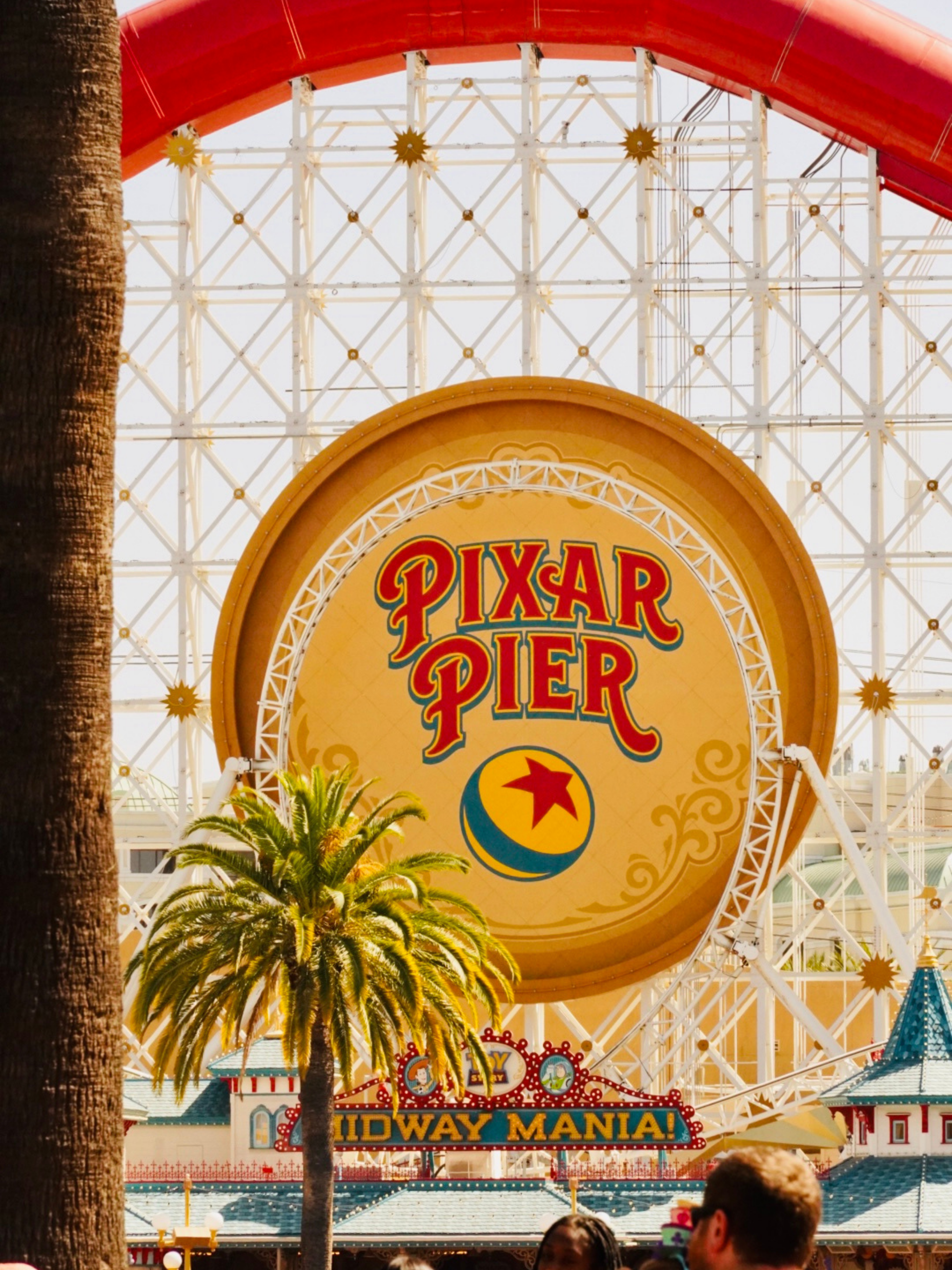 A large sign for pixar pier in front of a palm tree photo – Free Disney ...
