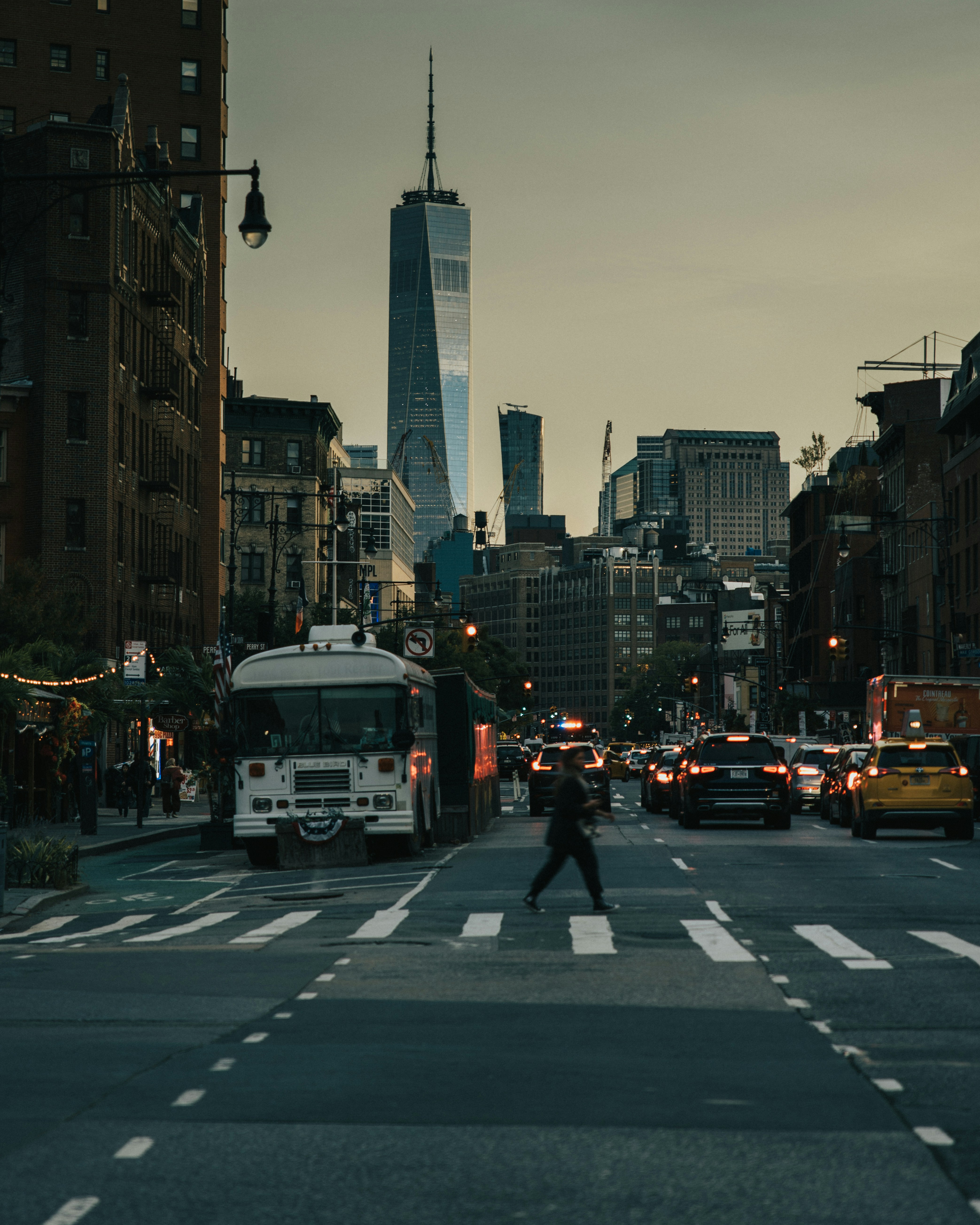 a person crossing the street in front of a bus