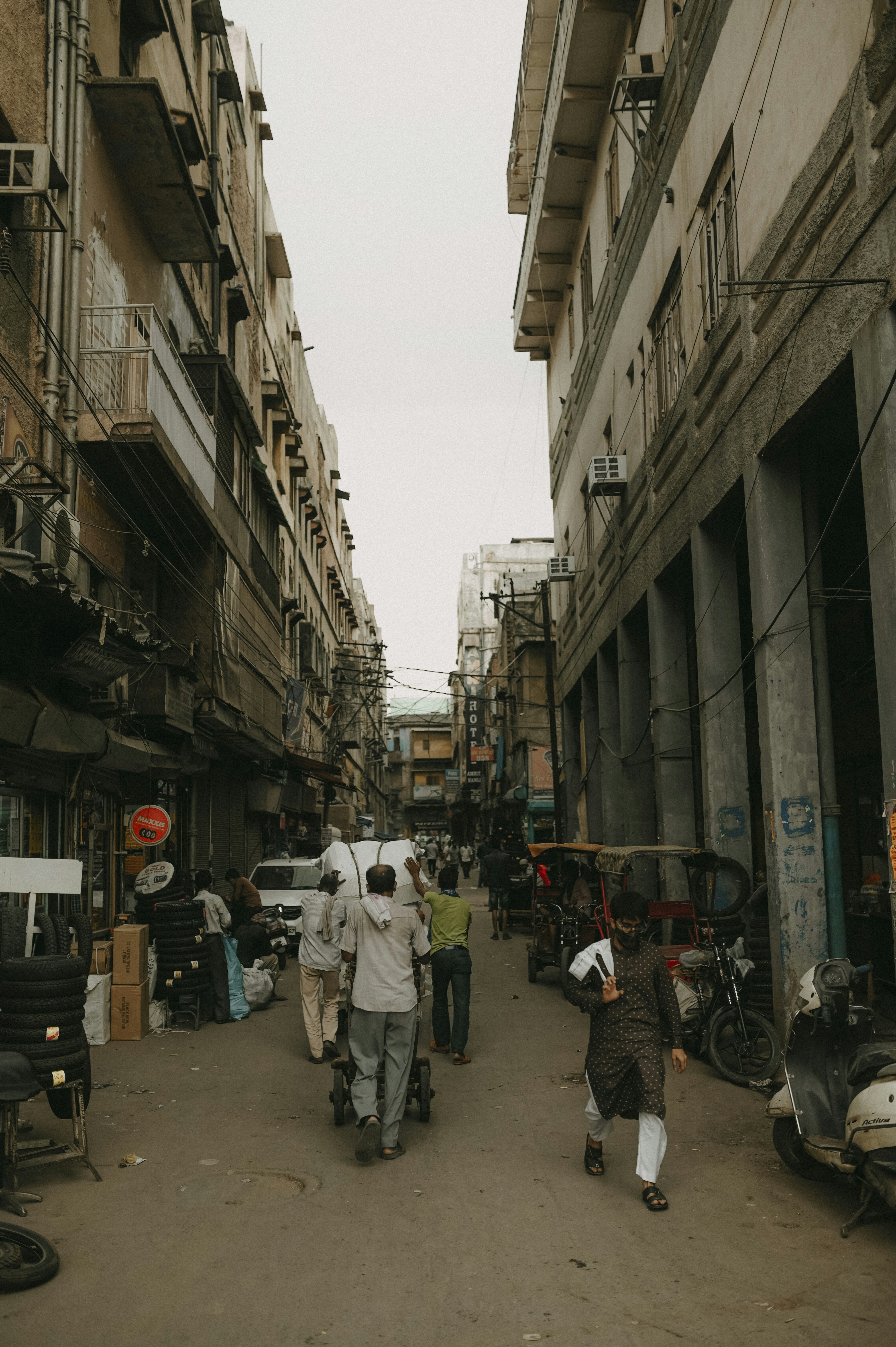 Bustling market street filled with people and vehicles, showcasing the vibrant everyday life in an urban setting.