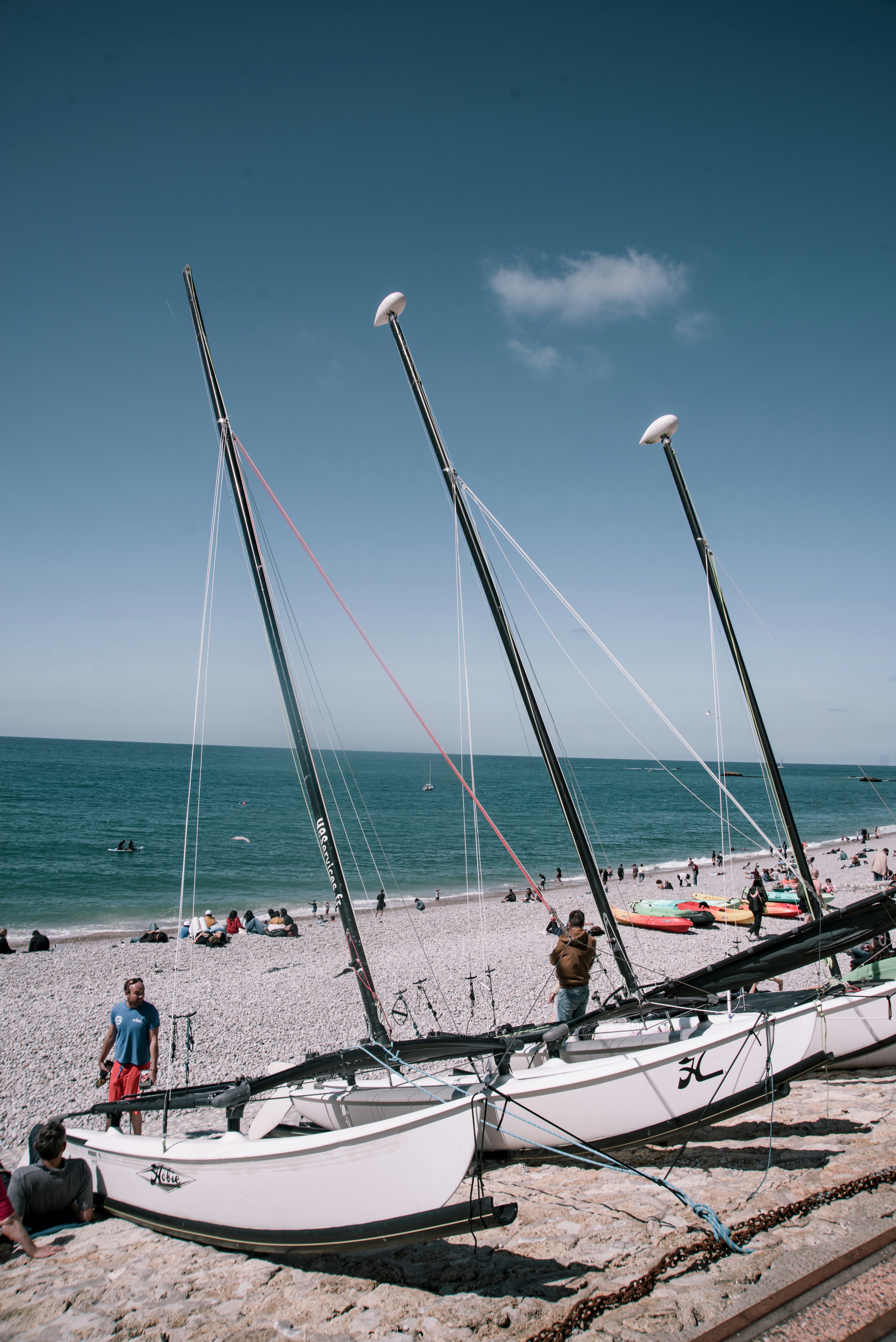 A couple of sail boats sitting on top of a beach photo – Free Étretat ...