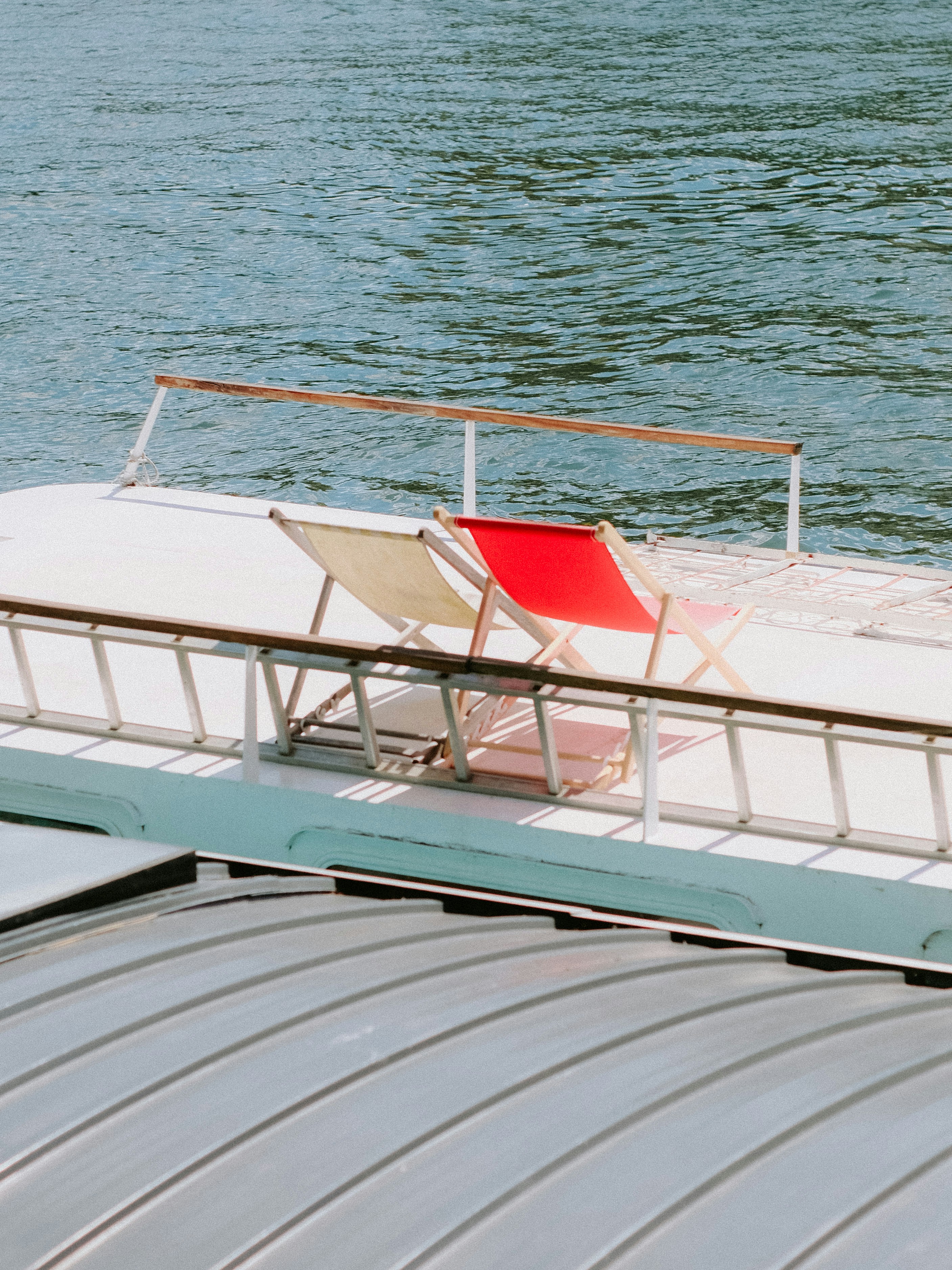 a couple of chairs sitting on top of a boat