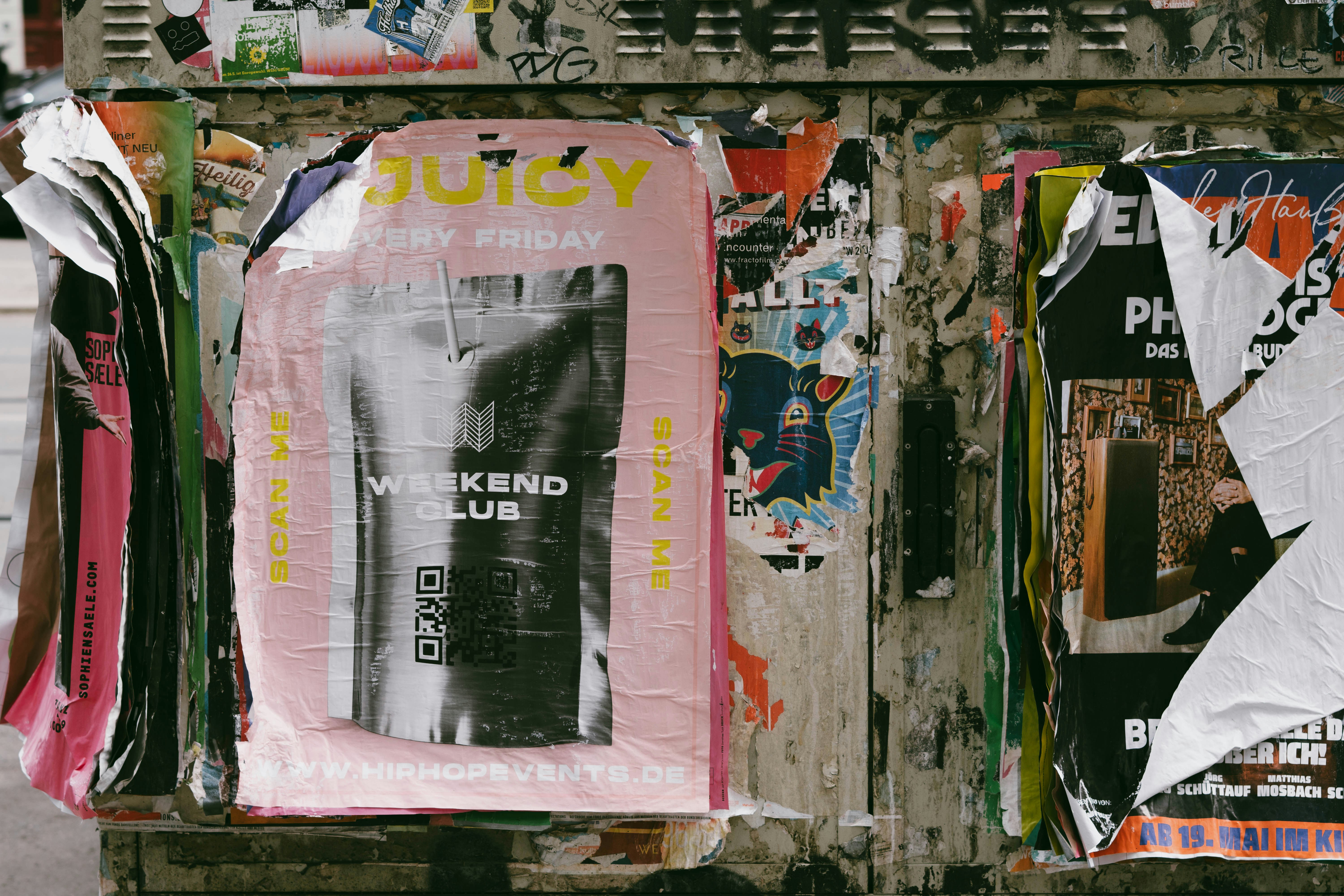 A bunch of posters on the side of a building photo – Free Berlin Image ...