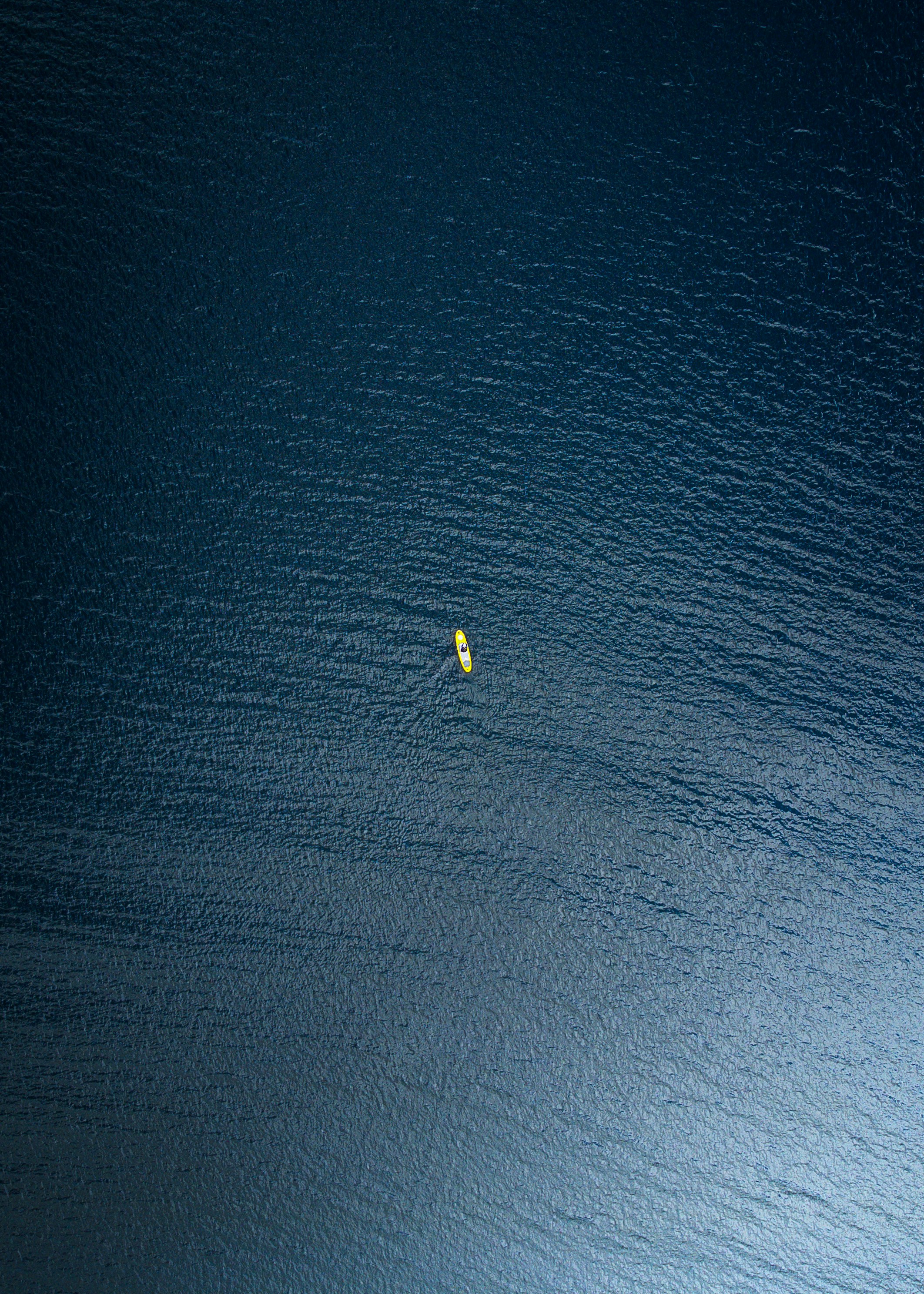 A paddle boarder out on the water in the Lake District. 