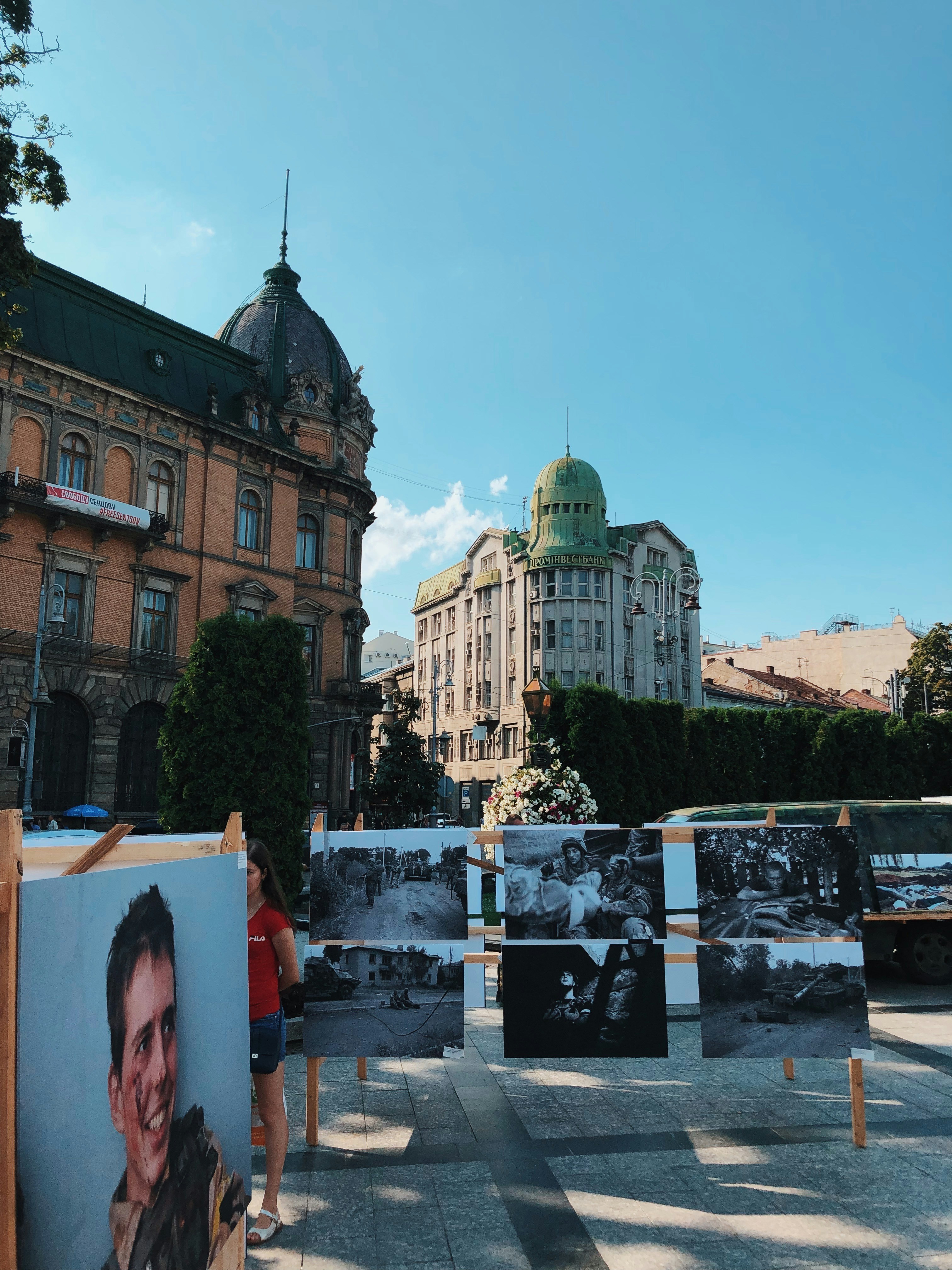 A group of people standing next to each other near a building photo ...