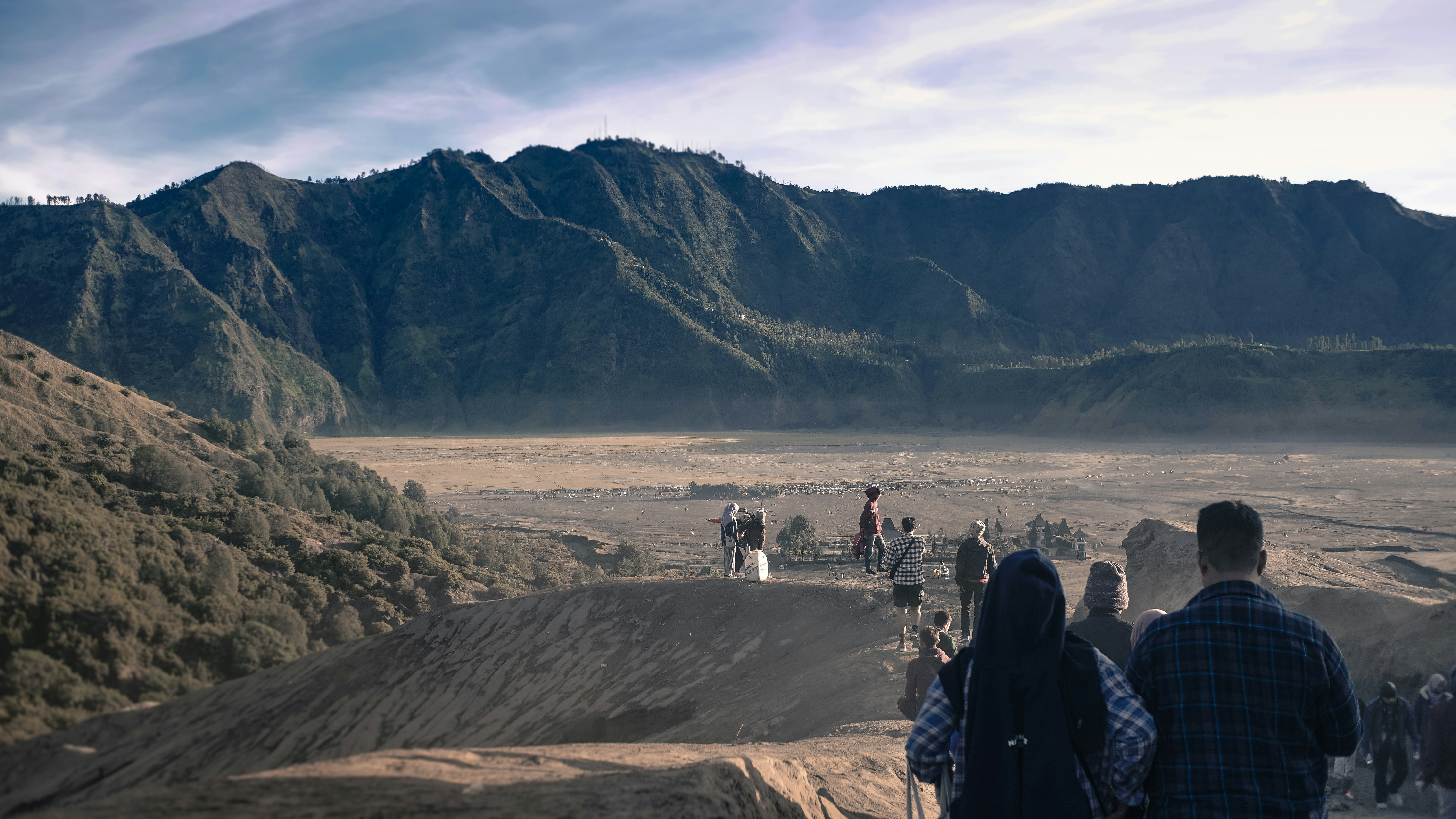 Ridgewalkers at Dawn: A Silhouette of Steps and Smoke on a Volcanic Plain