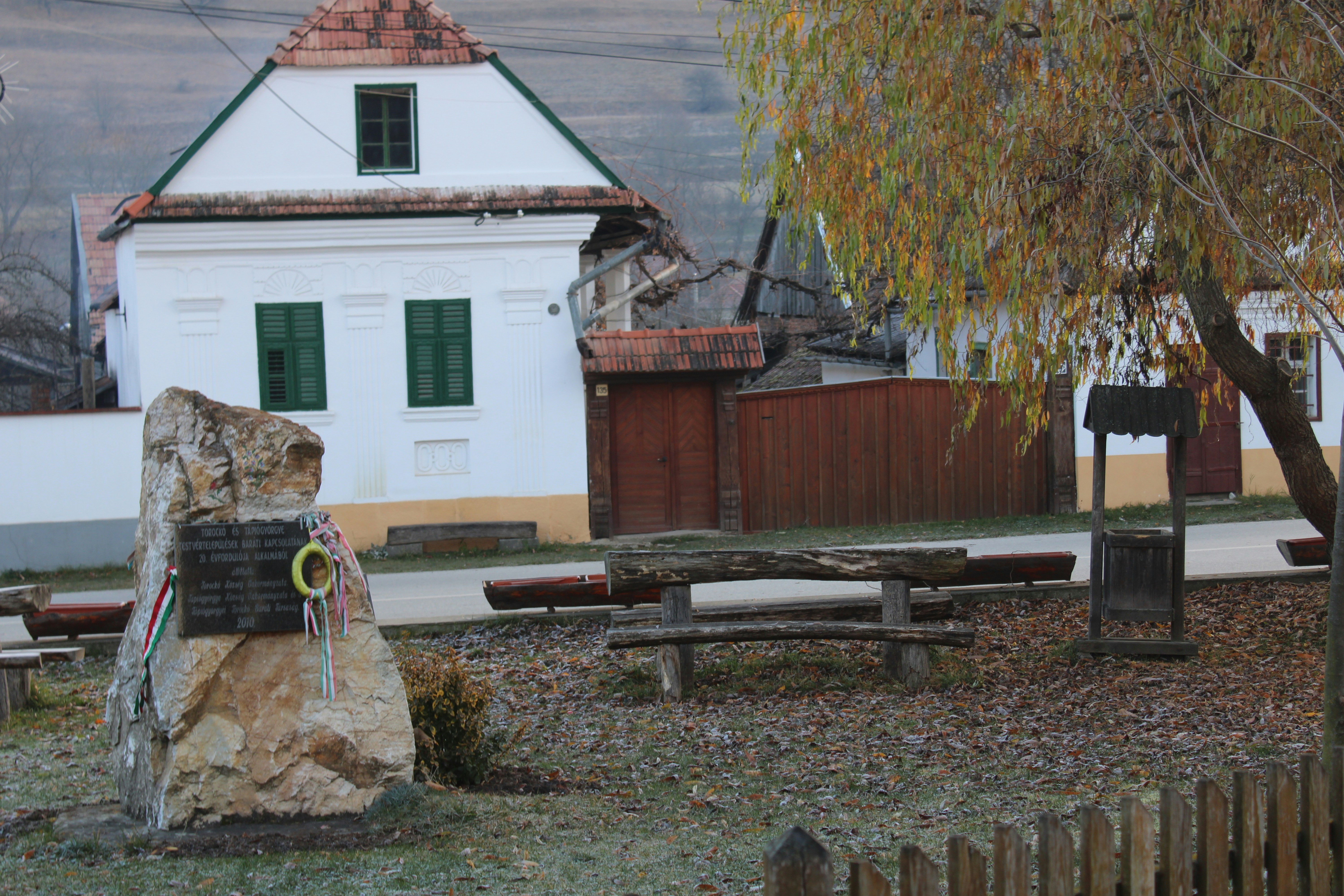 Ribboned Monument and a White-Gabled House: An Autumn Village Portrait