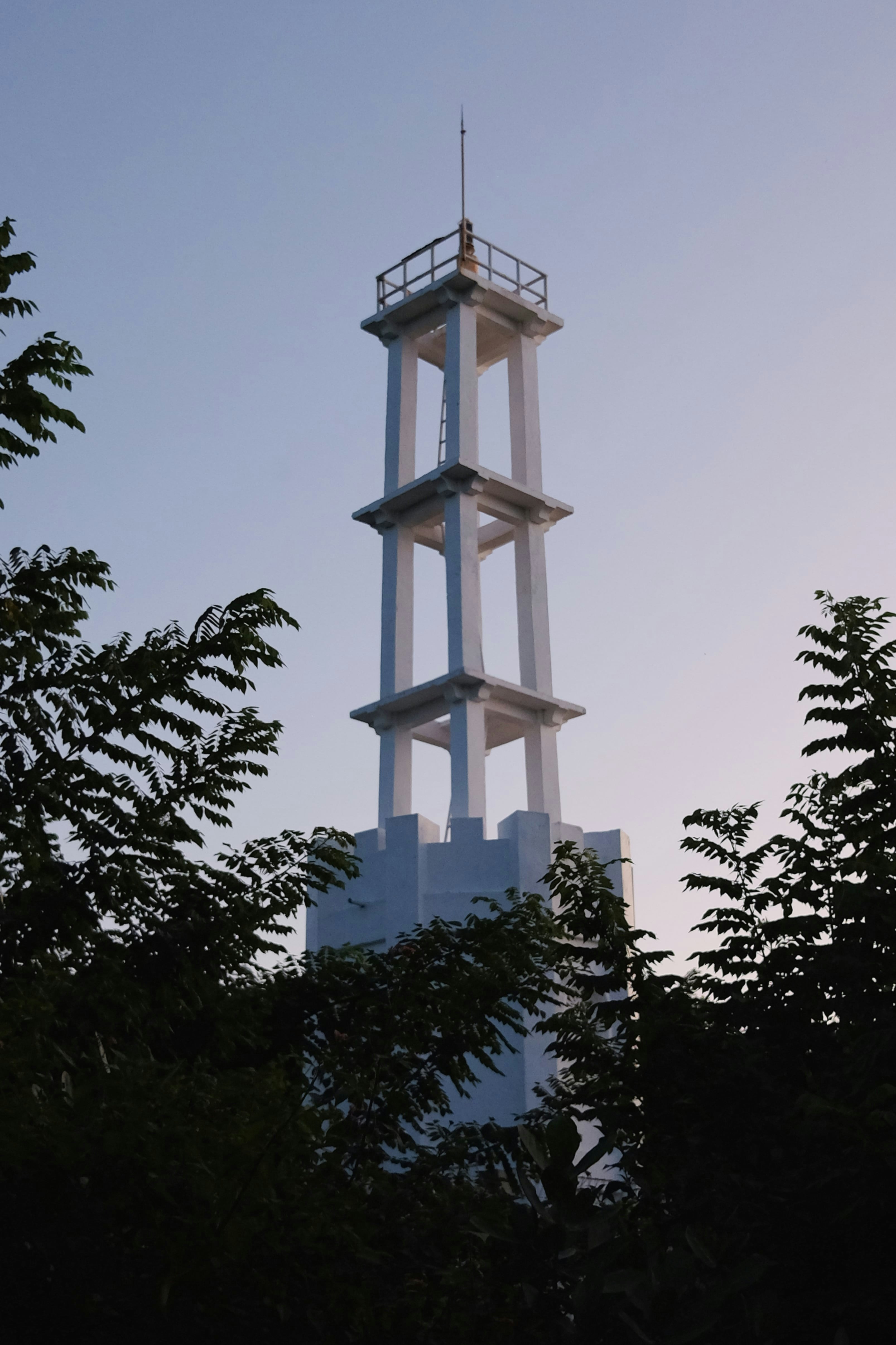 A tall white tower with a clock on it's side photo – Free Indonesia ...