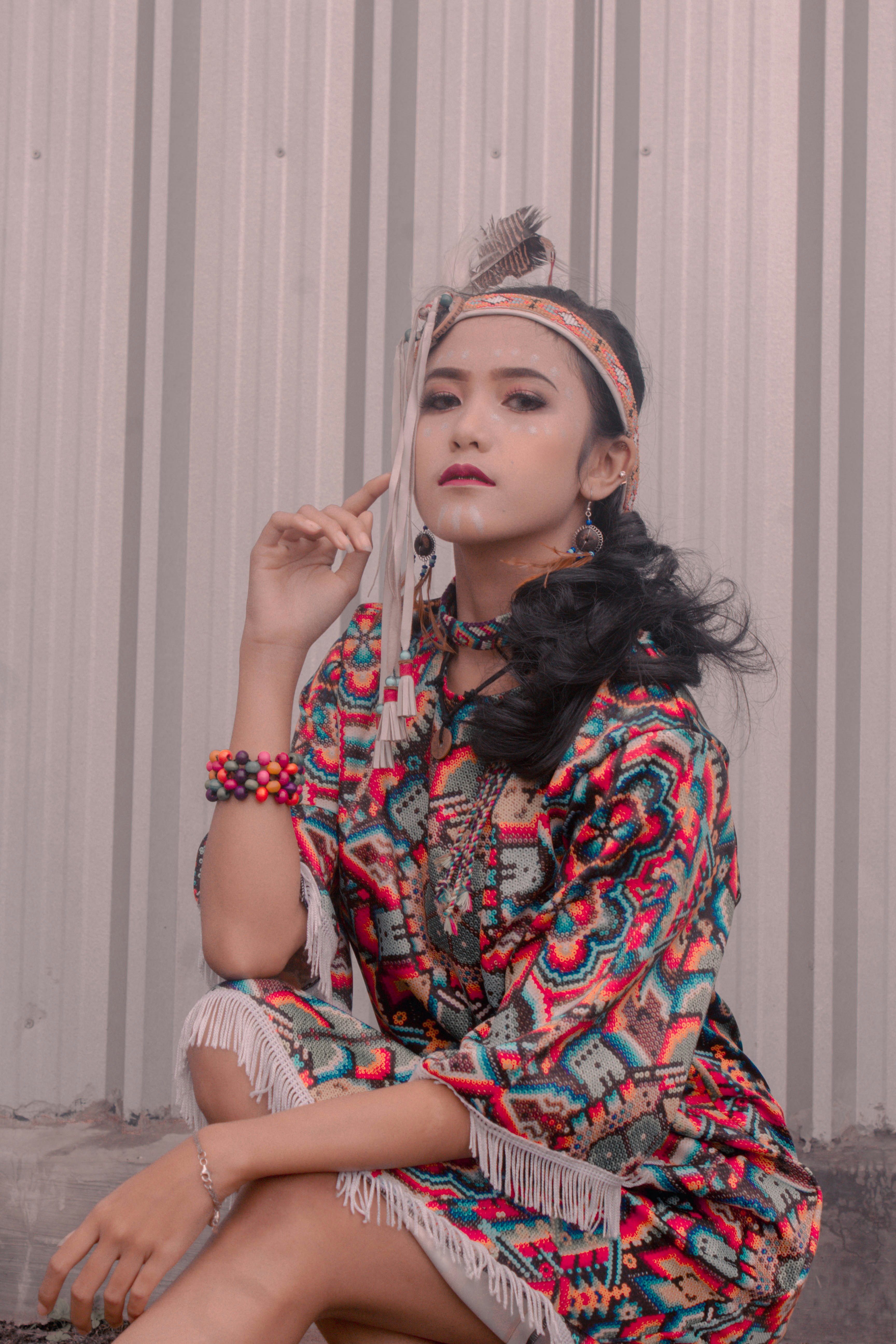 Feathered Bohemia: Portrait of Colorful Confidence Against a Corrugated Backdrop
