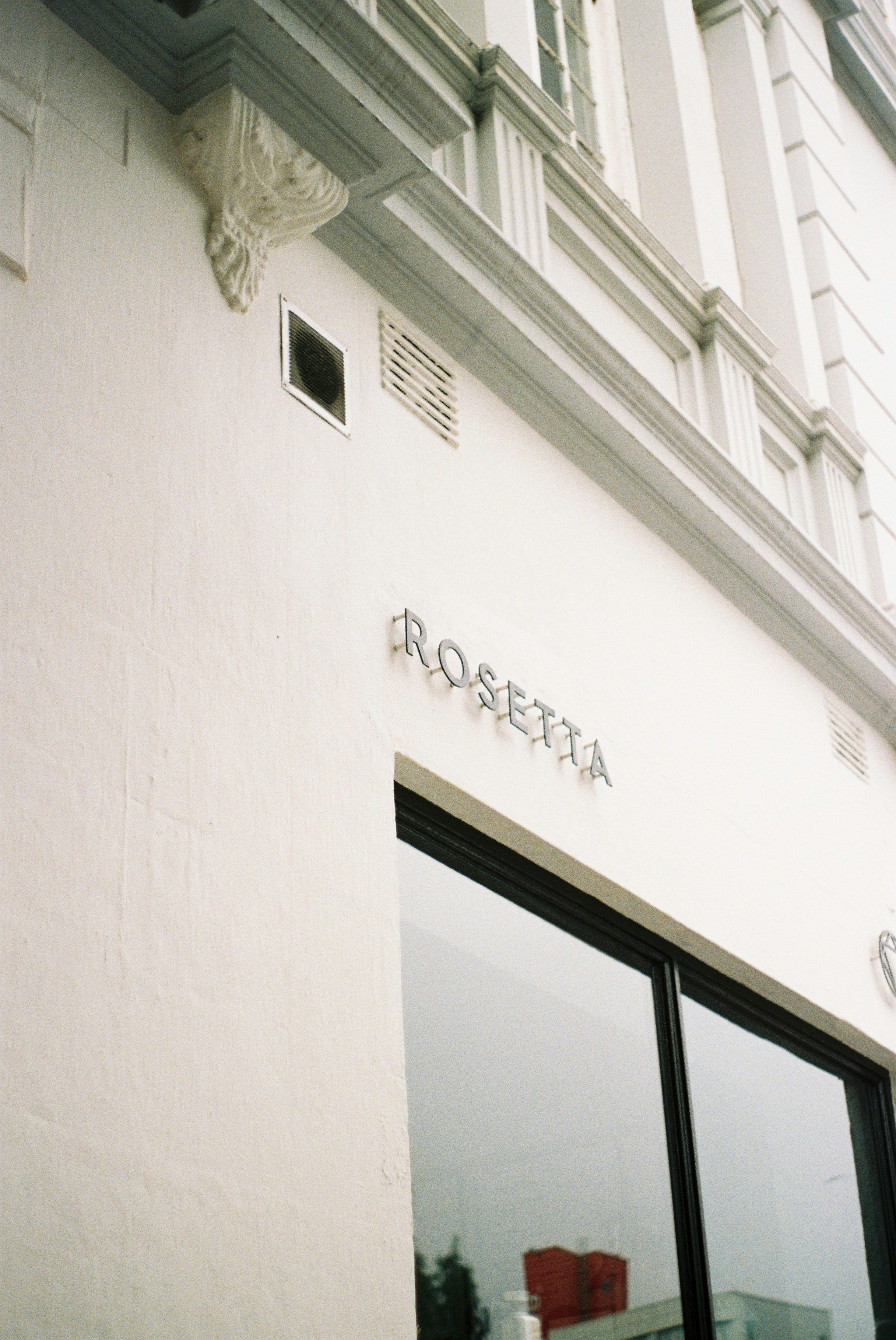Facade in Soft Light: Rosetta Sign Above Modern Glass