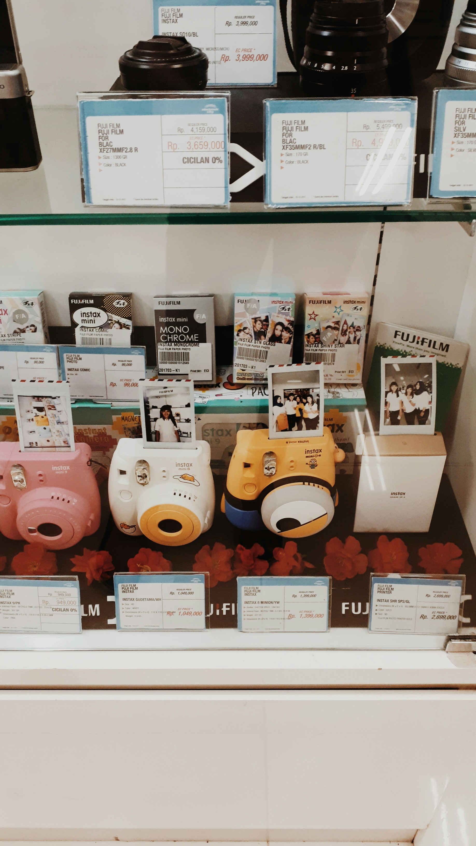 Pastel Instax Parade: A Row of Colorful Mini Cameras on Display