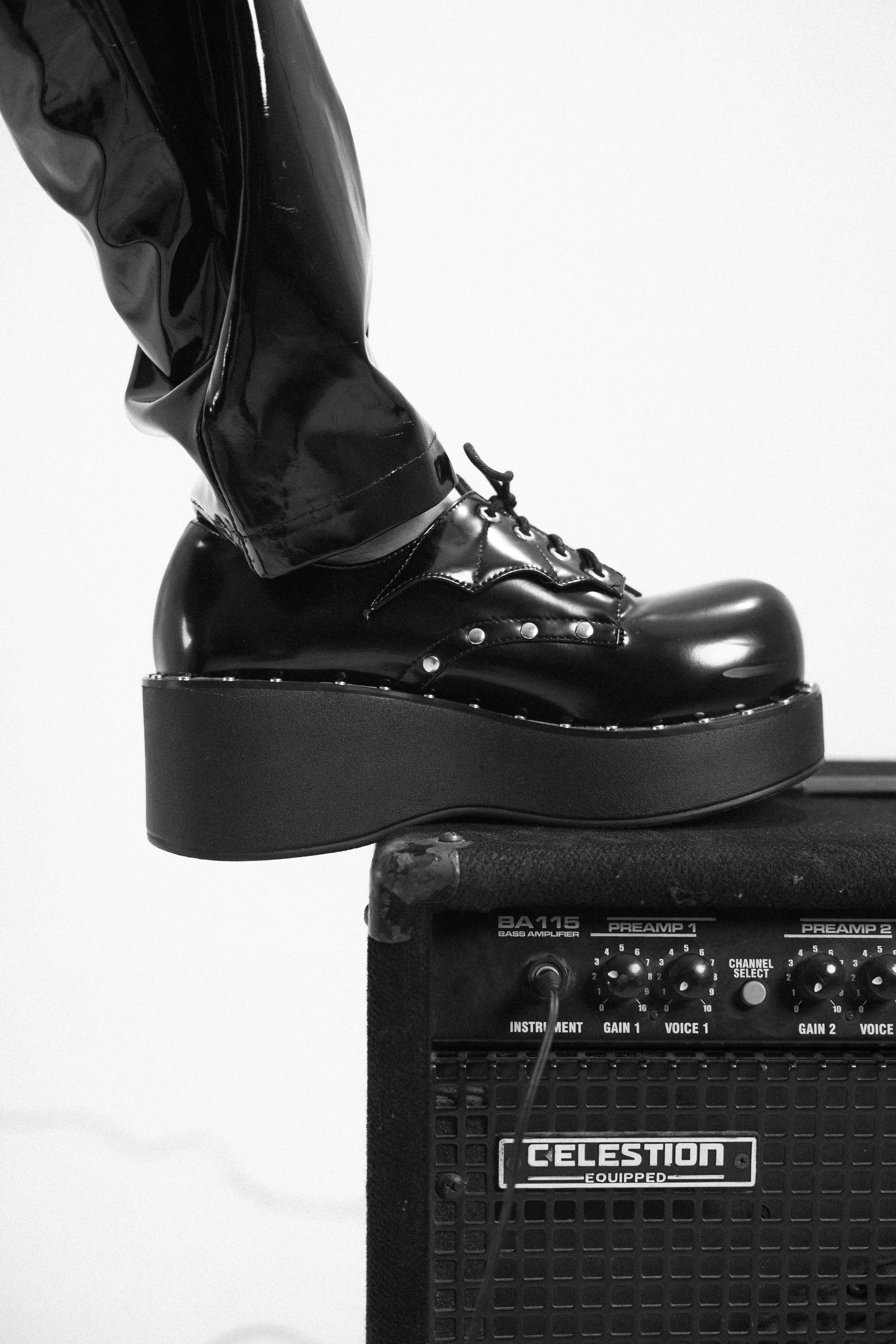 Monochrome Stomp: Patent Leather Boot on a Celestion Cabinet