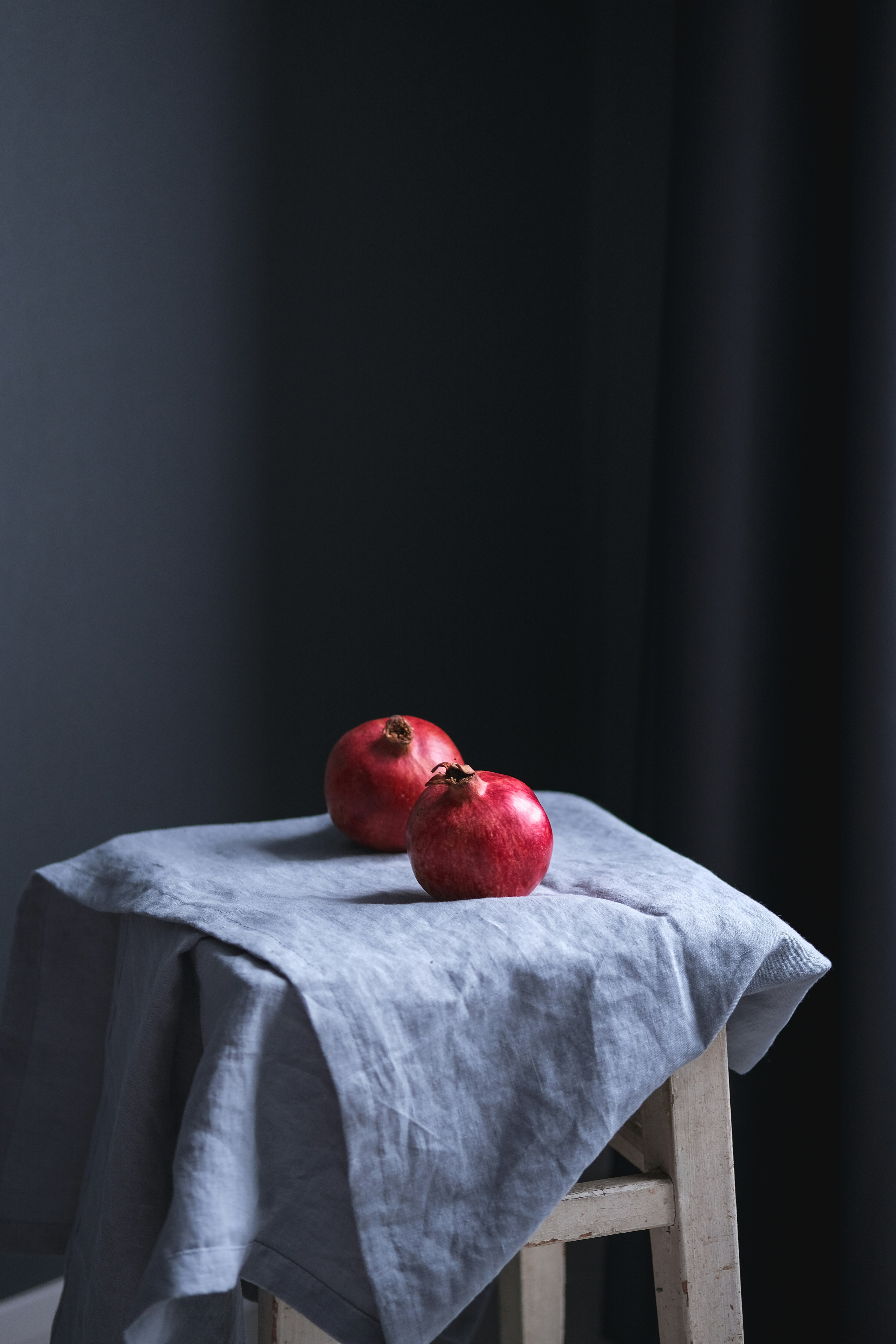 Crimson Quietude: Two Pomegranates on Linen