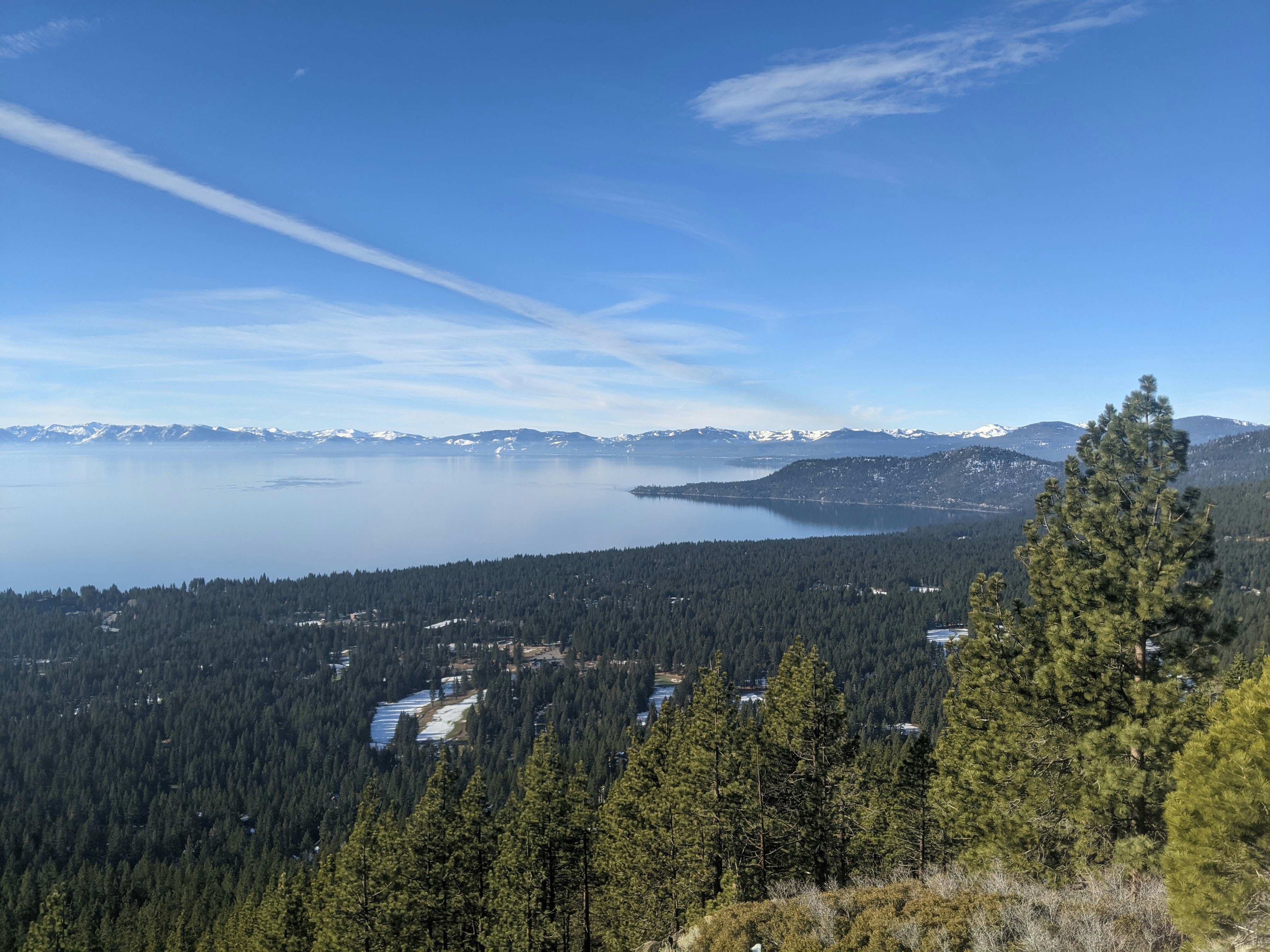 A scenic view of a lake surrounded by trees photo – Free Snow Image on ...