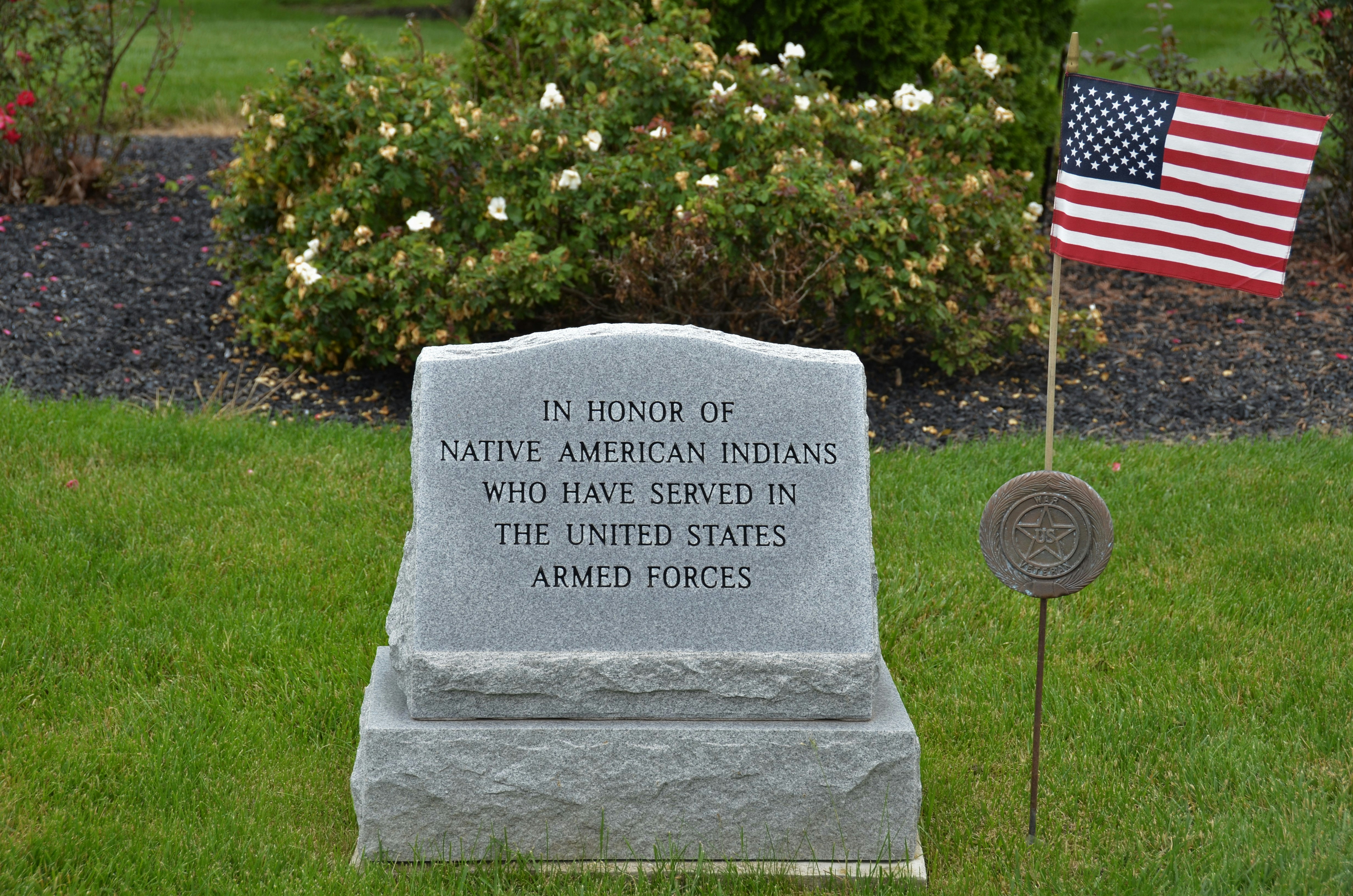 Honor Stone: Native Veterans Memorial with Flag and Medal