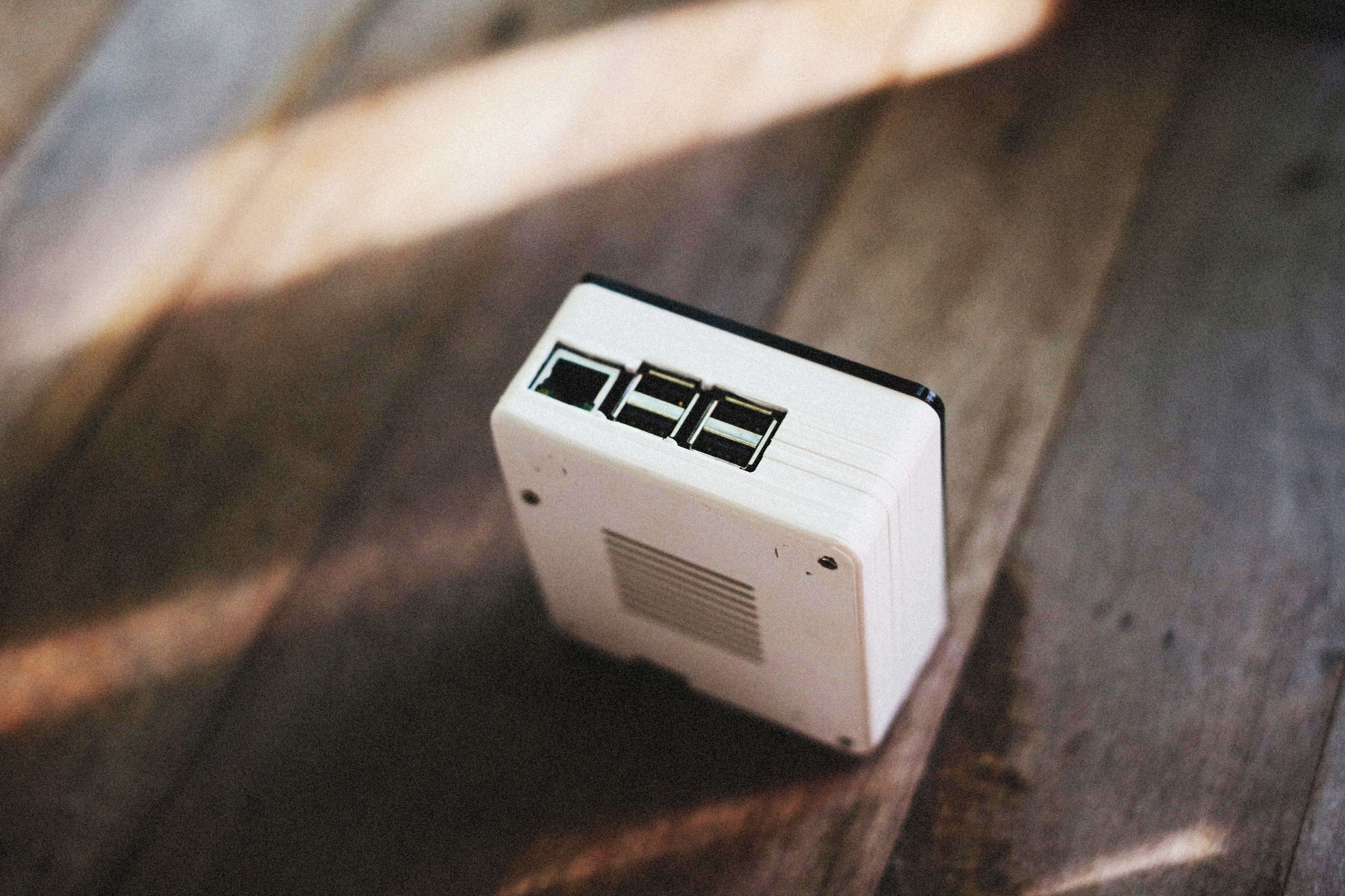 A small white computer sitting on top of a wooden floor photo – Free ...