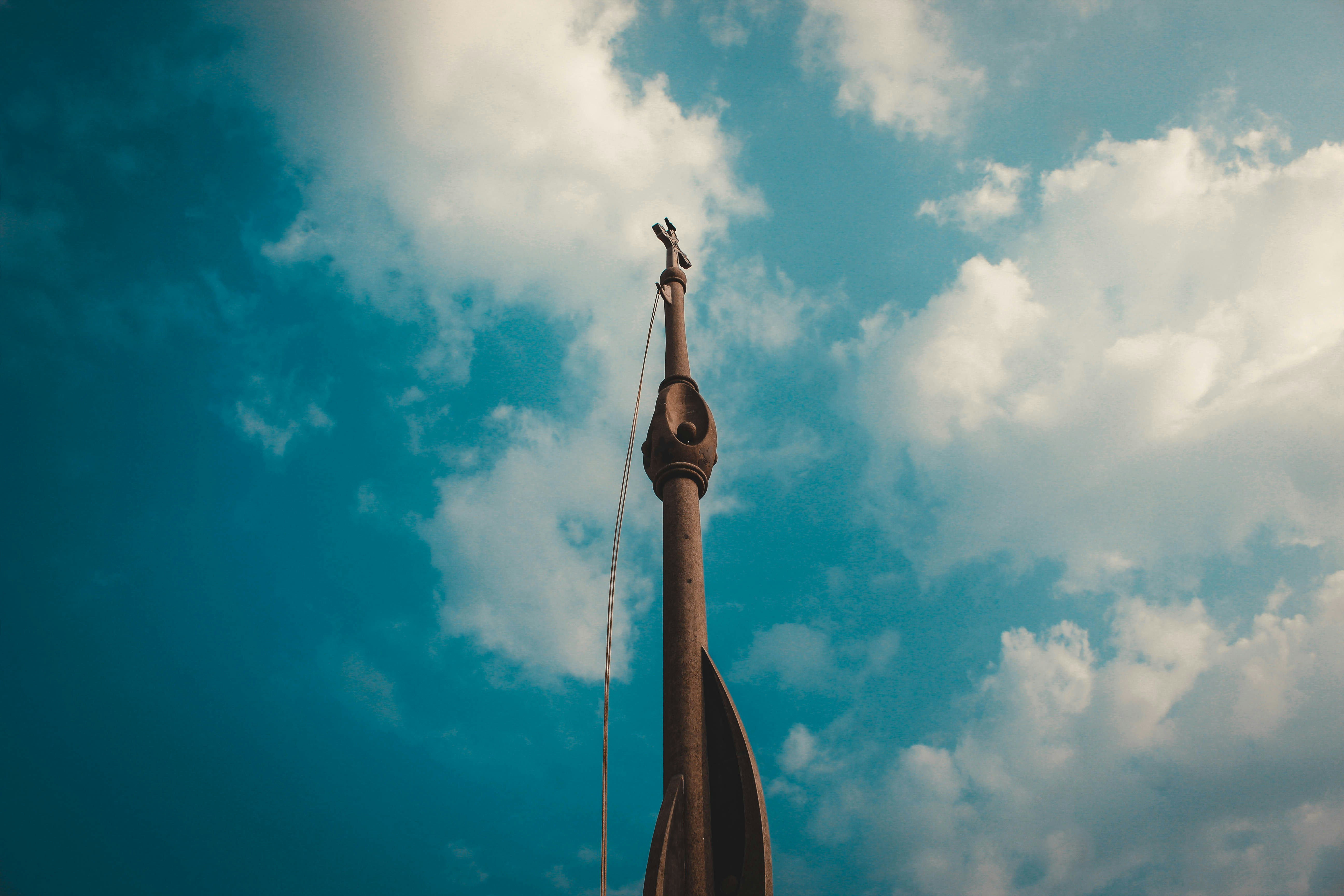 A tall tower with a bird perched on top of it photo – Free Blue Image ...