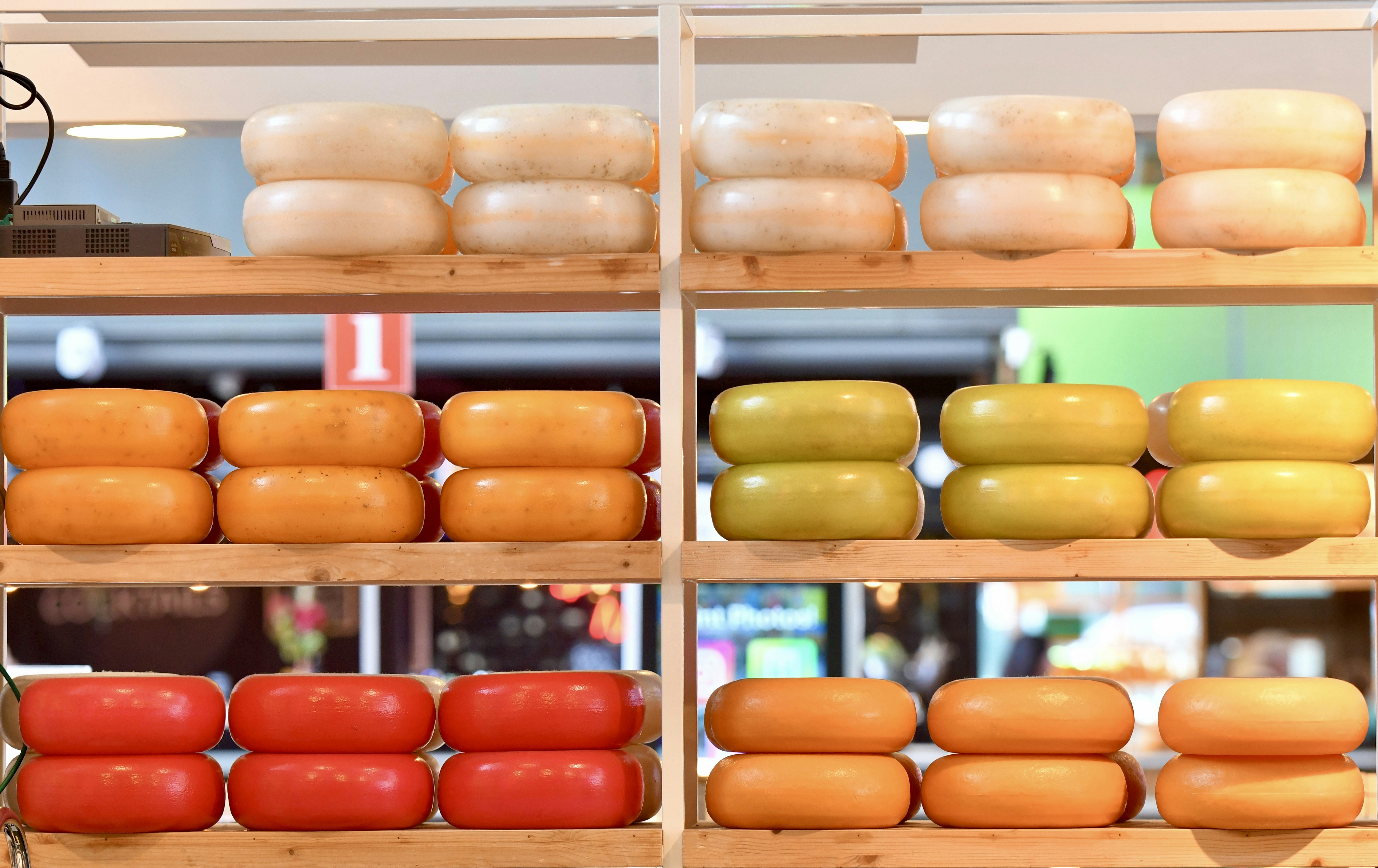 A display case filled with lots of different types of cheese photo ...
