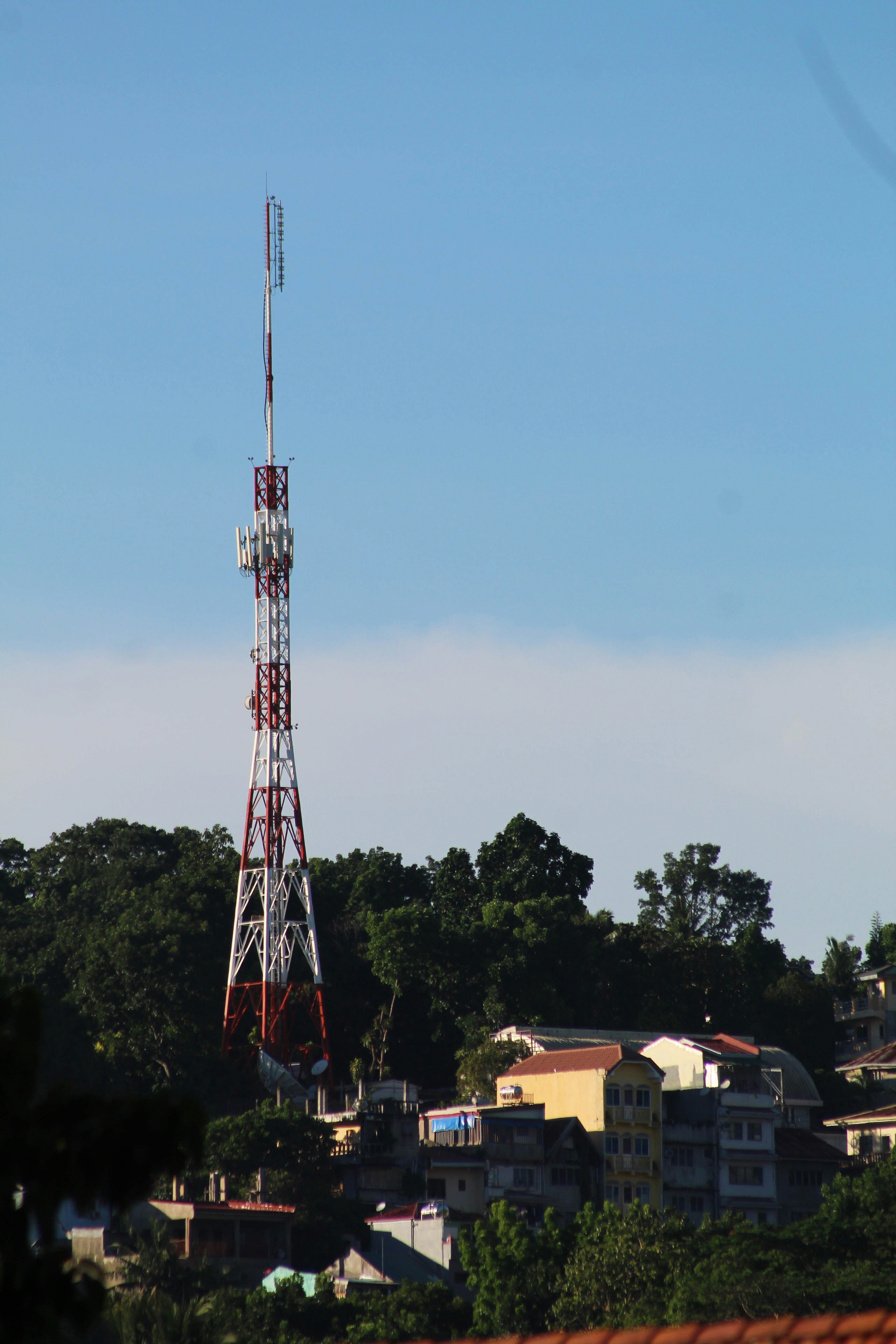 A cell phone tower in the middle of a city photo – Free Oppra unit 2 ...