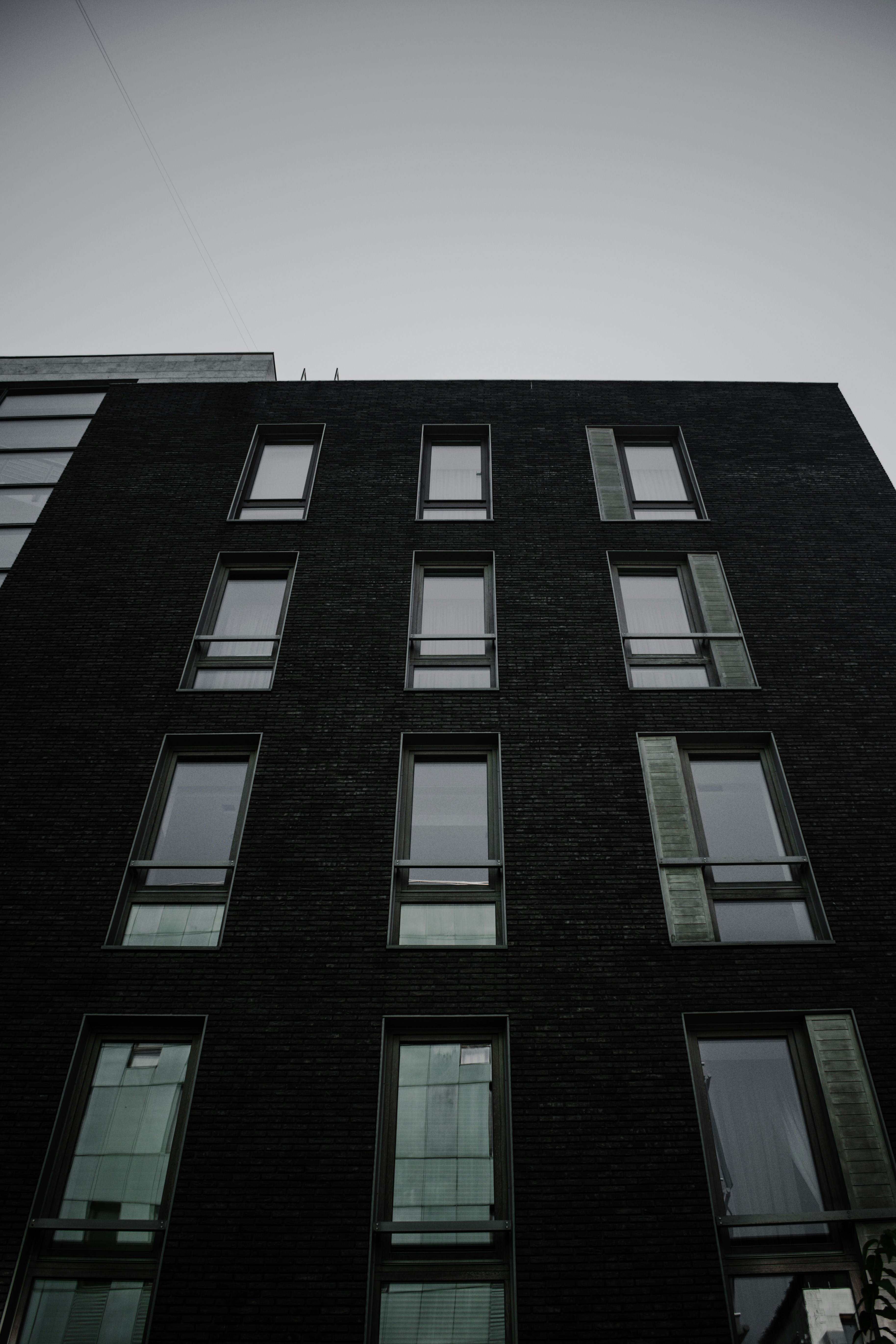 A tall black building with lots of windows photo – Free Wallpaper Image ...