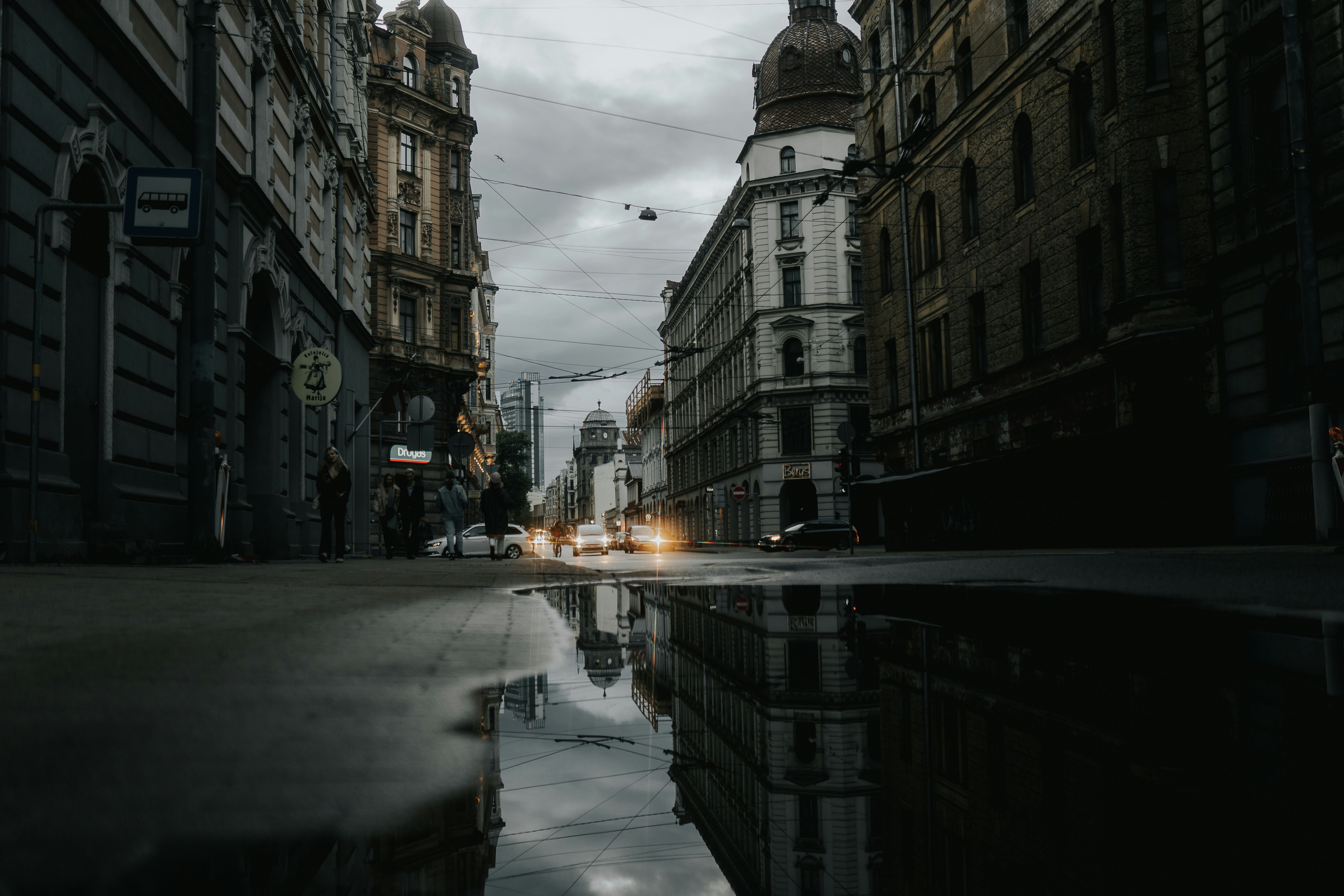 A narrow city street with buildings in the background photo – Free Riga ...