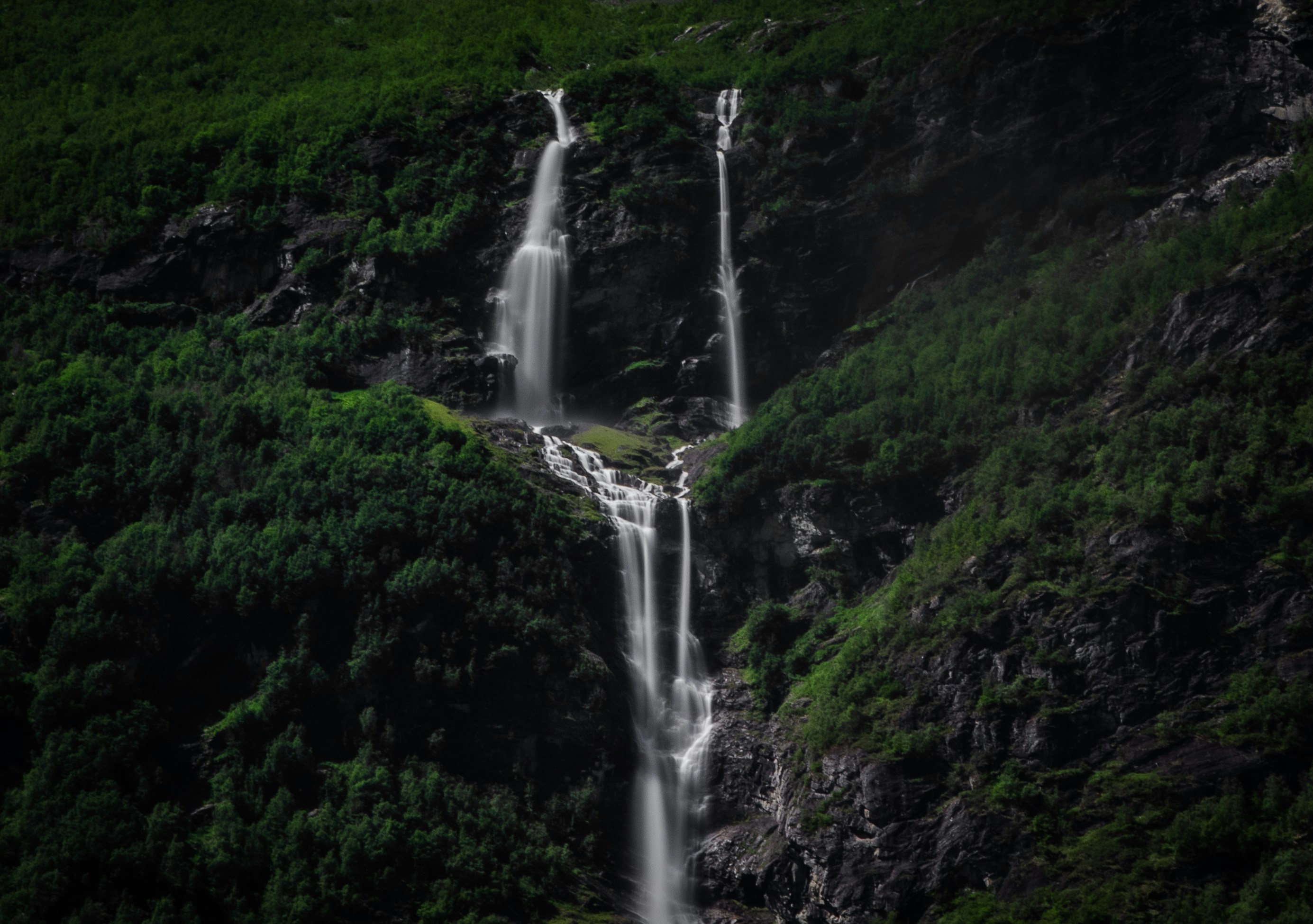 A tall waterfall with a waterfall running down it's side photo – Free ...