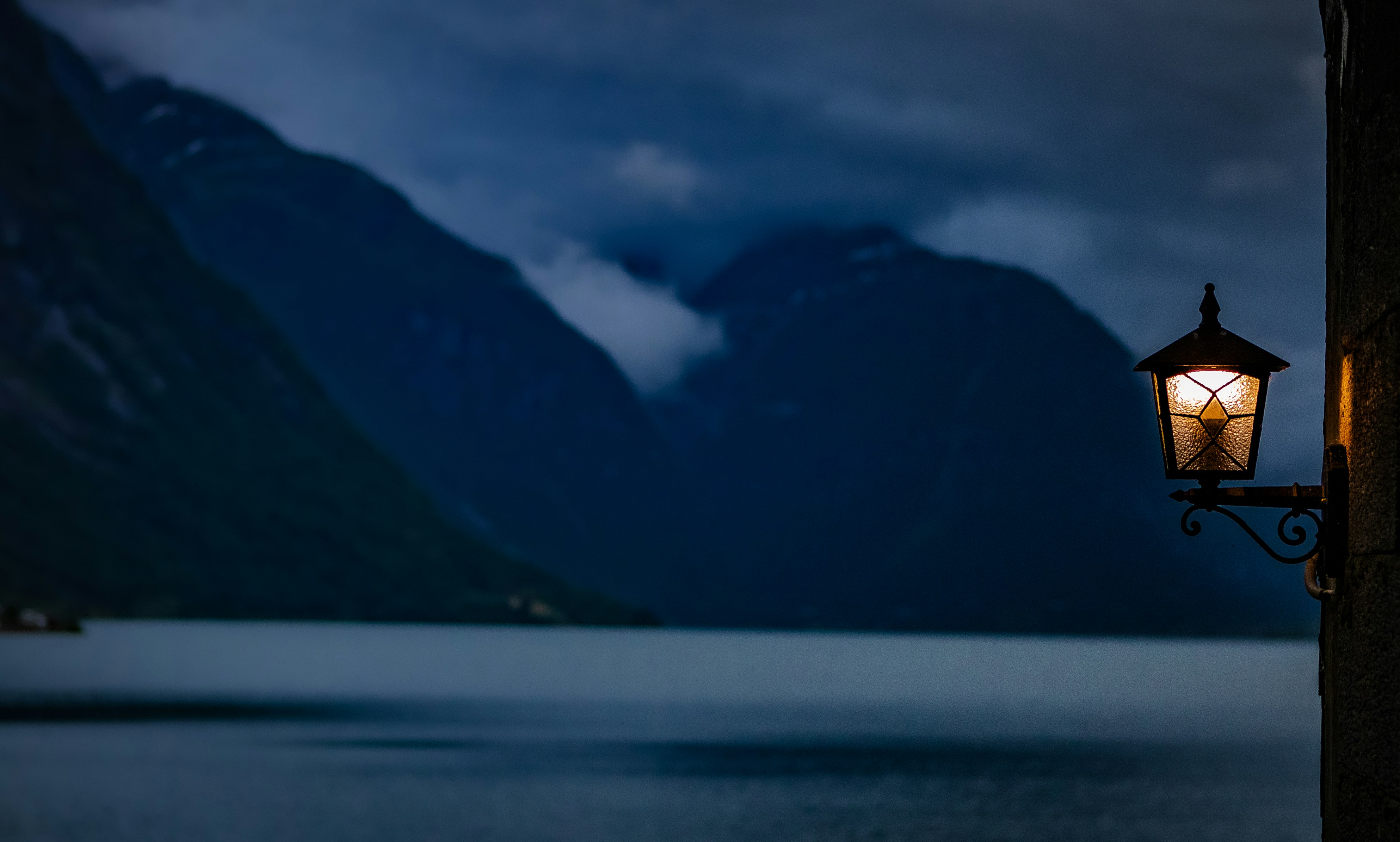 Lantern Glint at the Edge of Night over a Quiet Lake