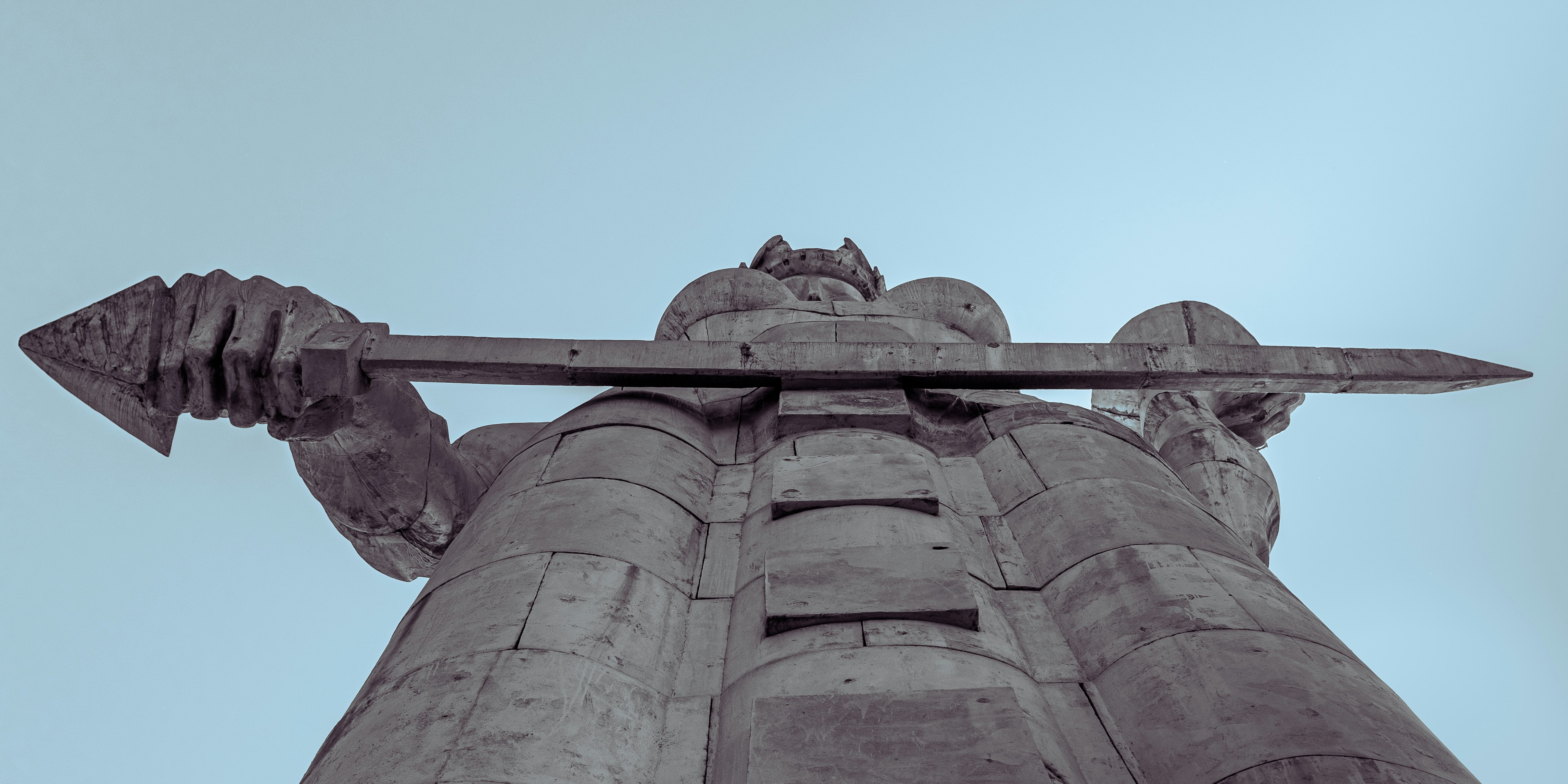 a statue of a man holding a large sword