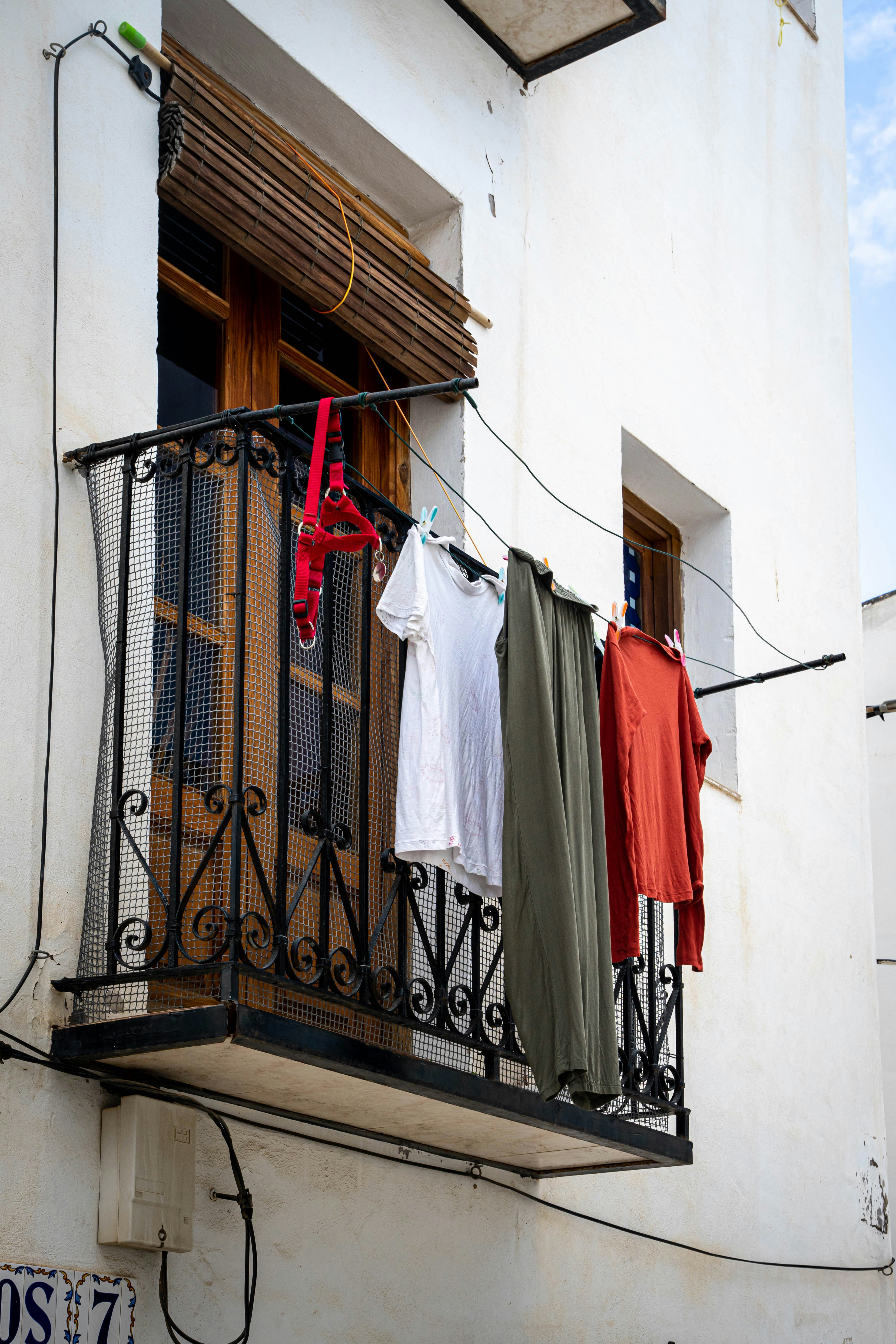Clothes hanging out to dry on a balcony photo – Free Balcony Image on ...