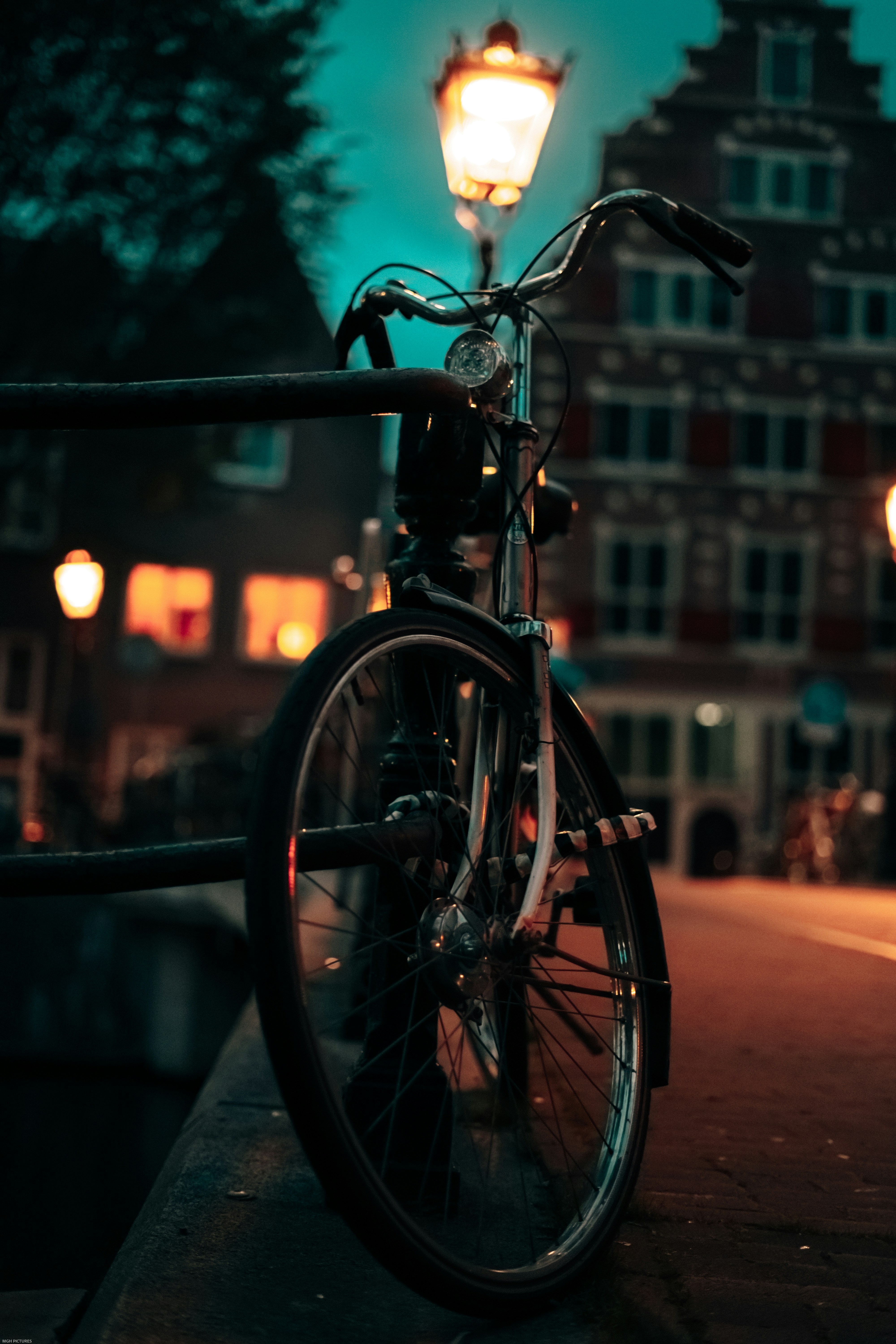 Midnight Lock Under Amber Streetlamps: A Bicycle Framed by City Night