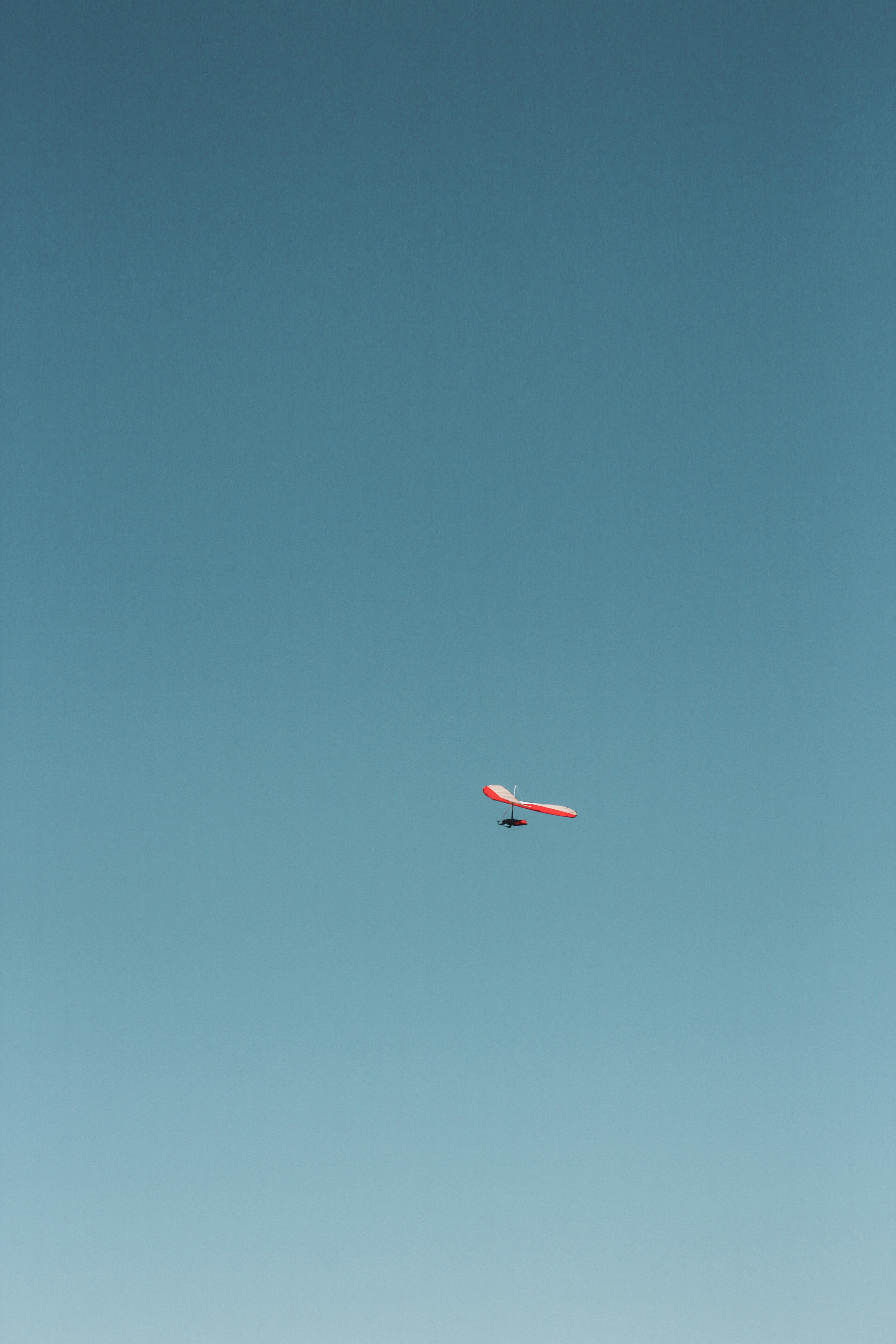 an airplane is flying in the blue sky