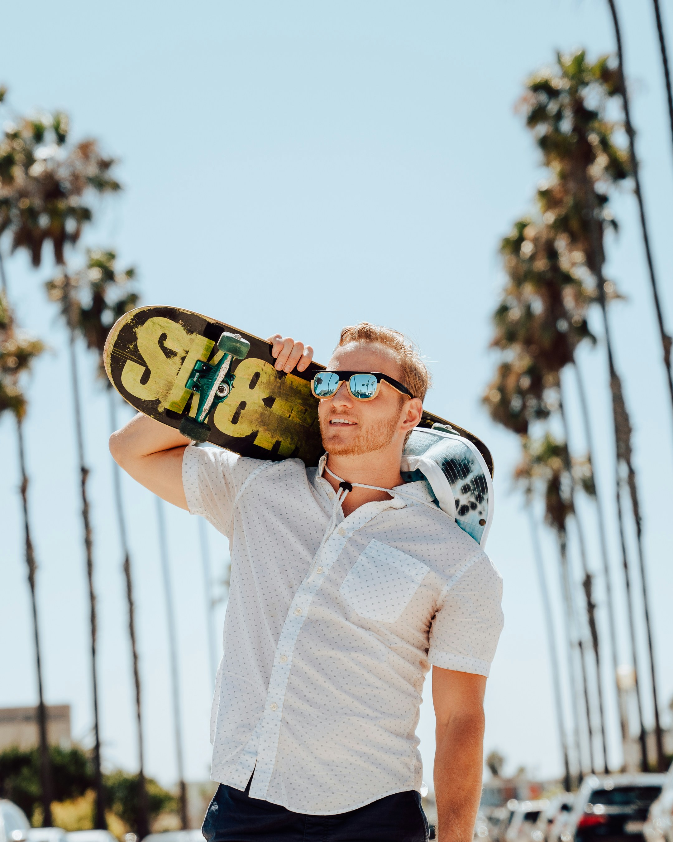 Sunlit Skater Under Palm Trees: A Casual Street Portrait