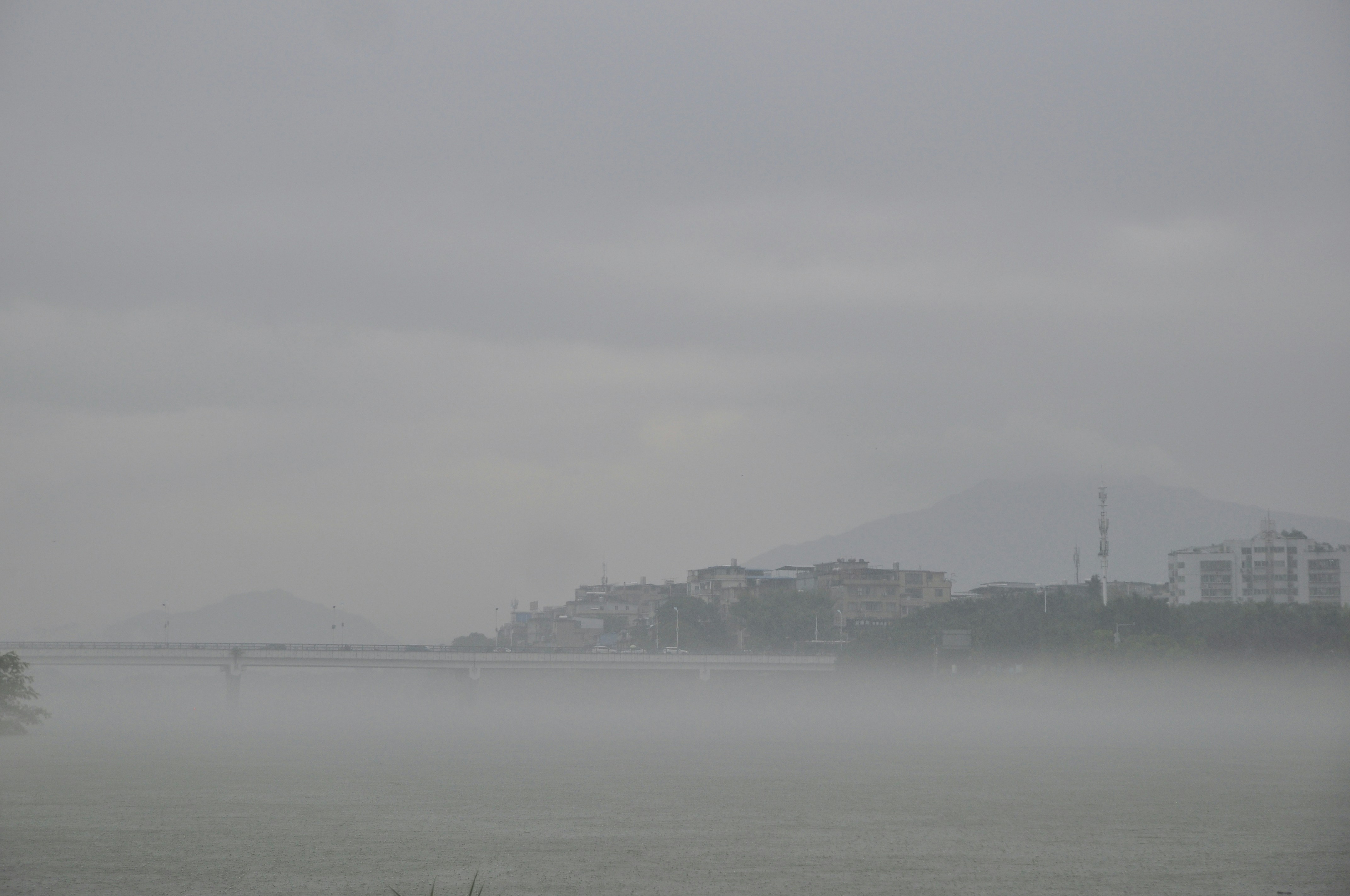 a body of water with buildings in the background