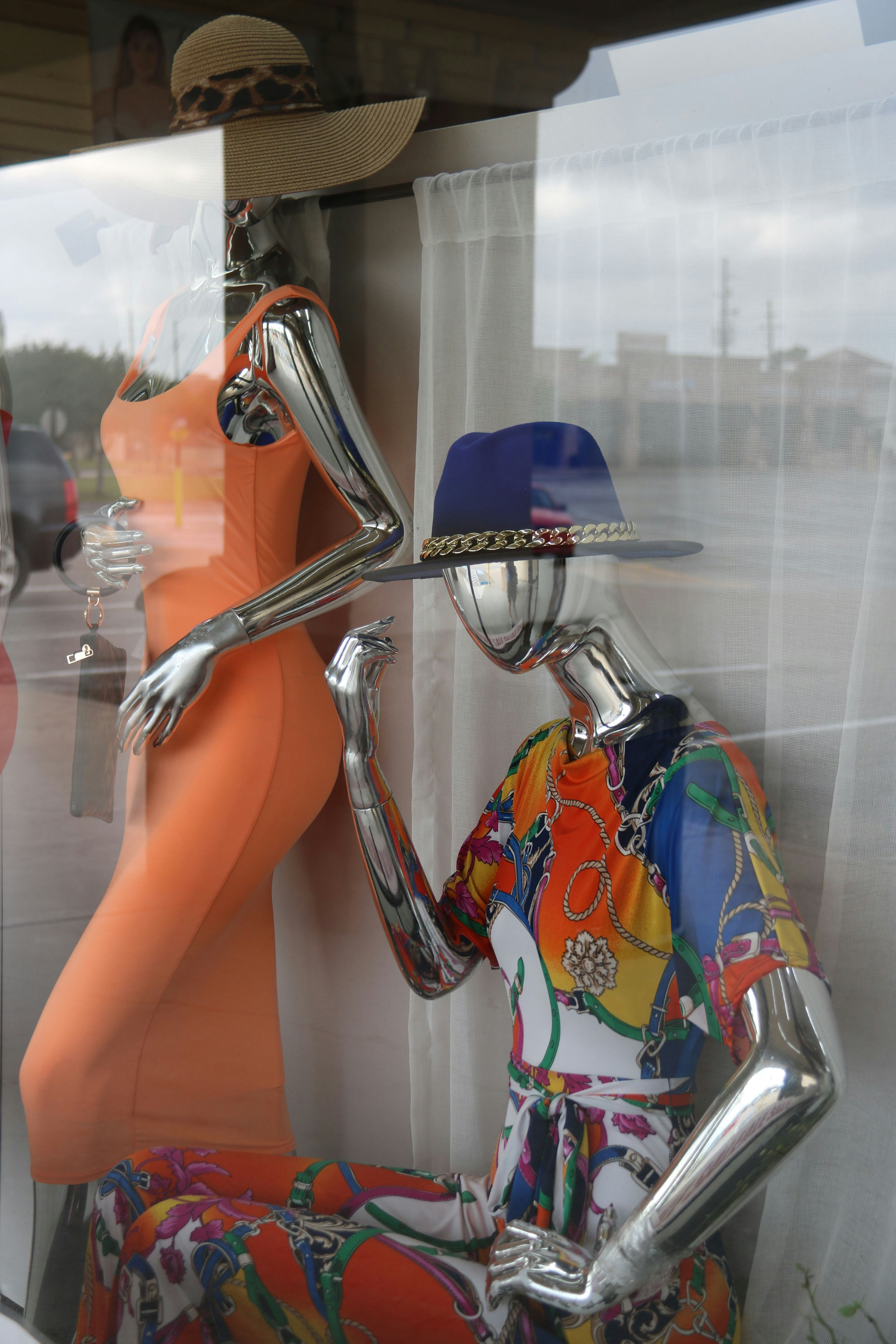 Reflective Style: mannequins in a window display flaunt bold patterns and vibrant accessories
