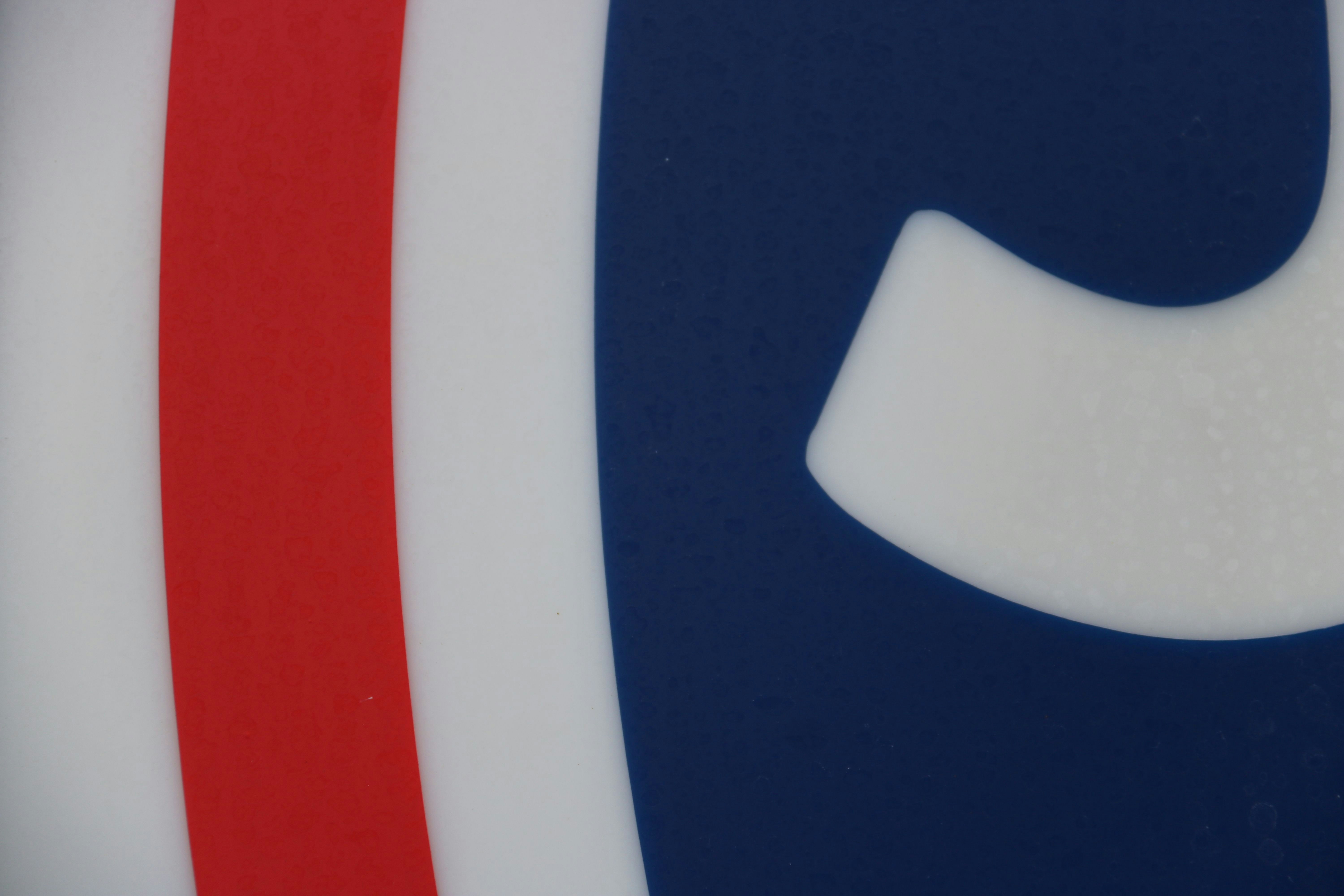 A close up of a red, white and blue logo photo – Free Abstract art ...