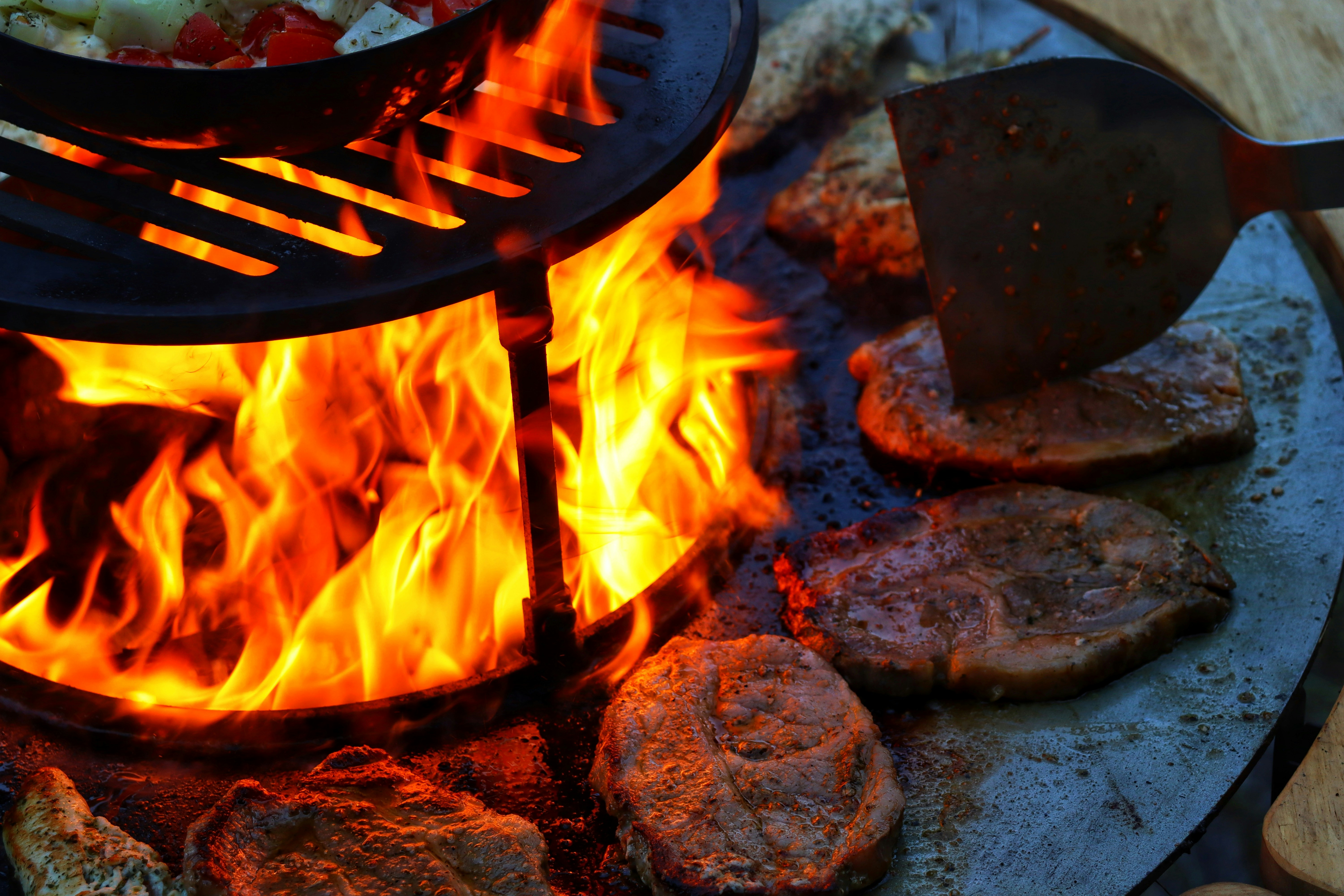 Flames, Grill, and burger patties: an outdoor sizzle
