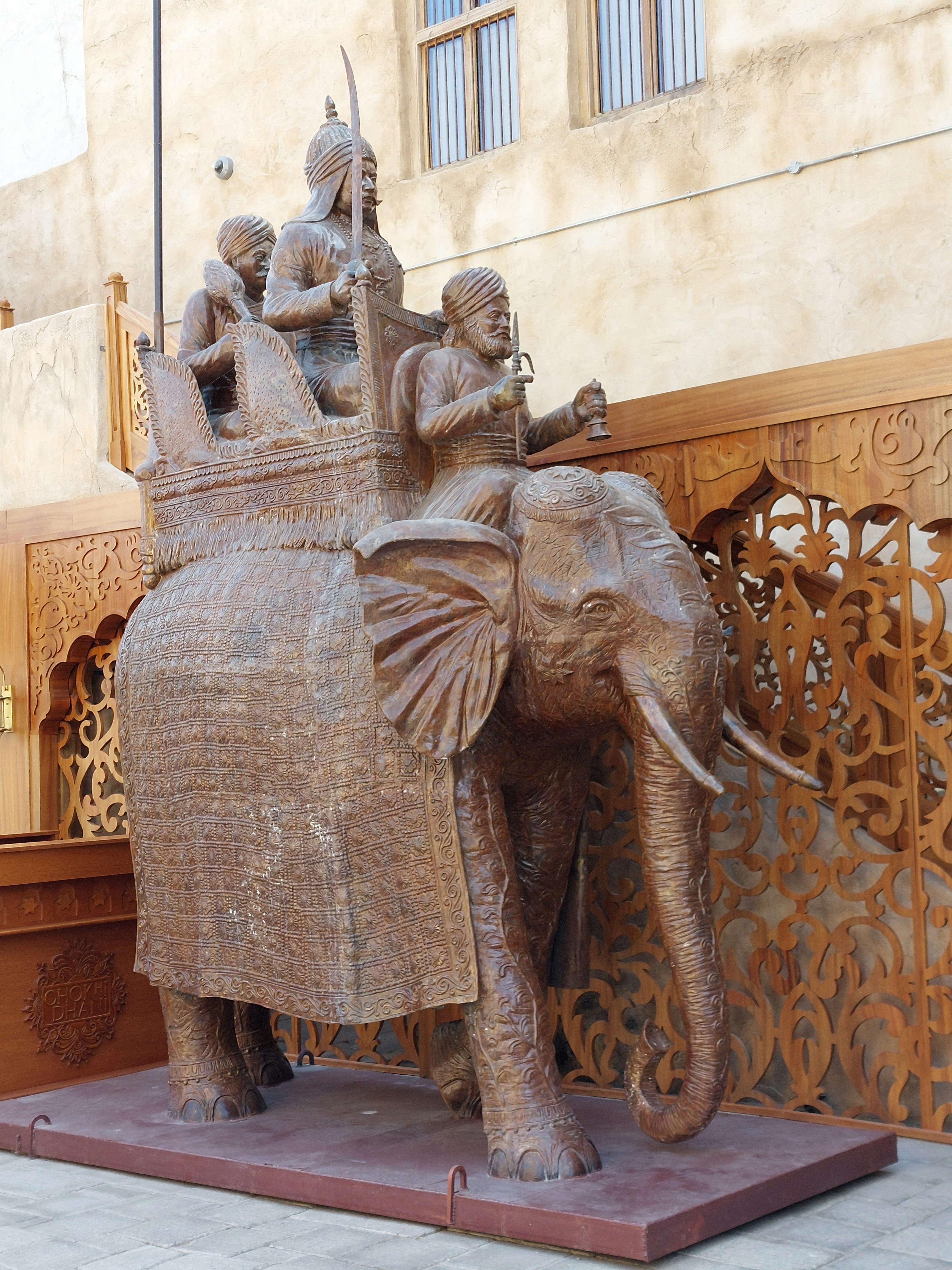 Bronze Elephant Caravan: Royal Riders in a Sunlit Courtyard